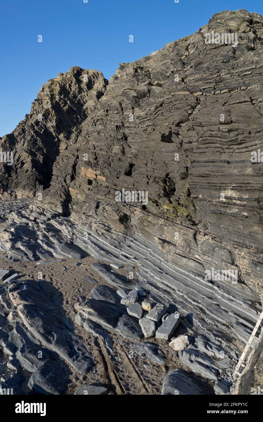 Beach with pebbles,rocks and stacked limestone strata in Ceredigion ...