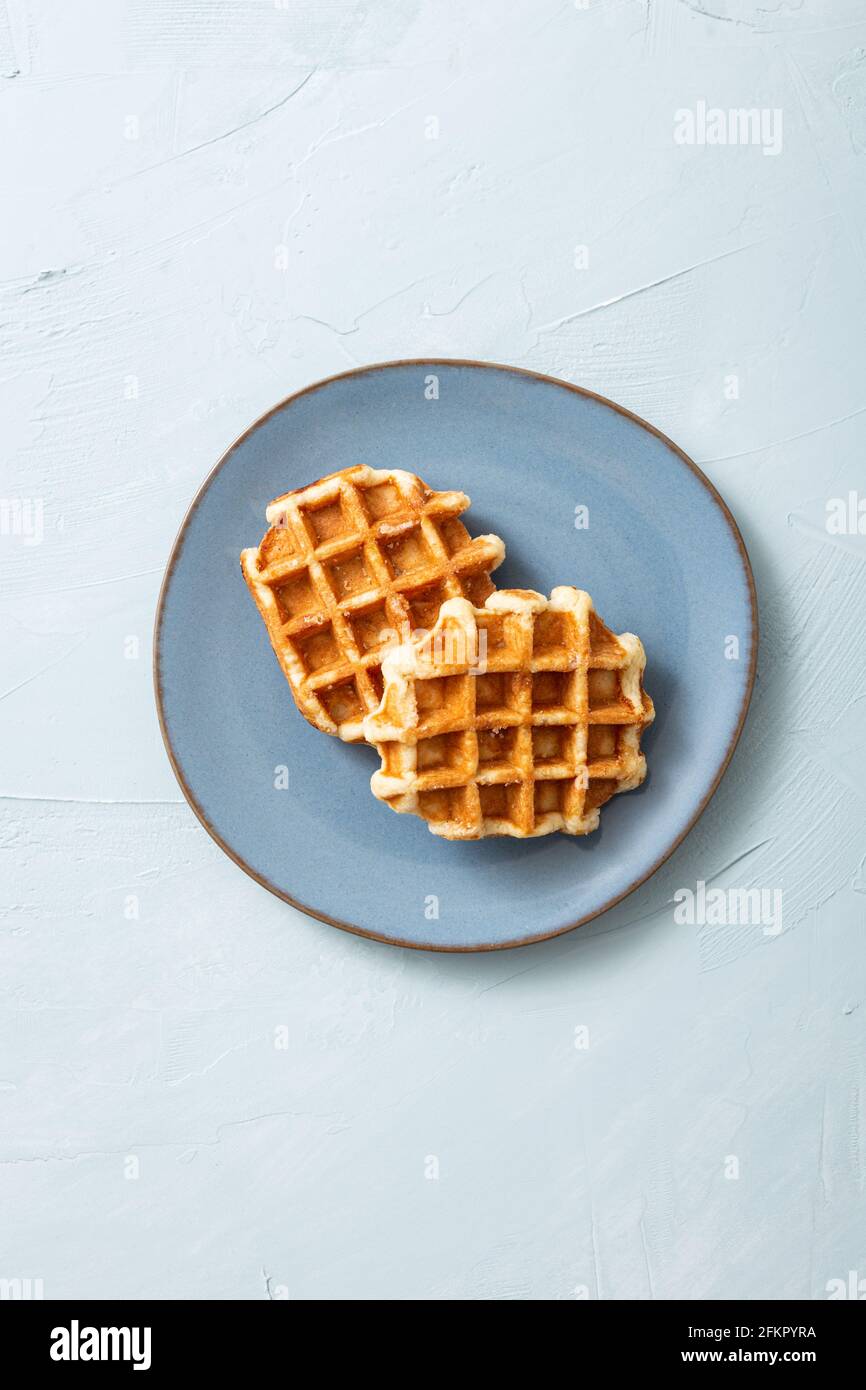 Vertical shot of commercial food photography with waffles on a gray ...