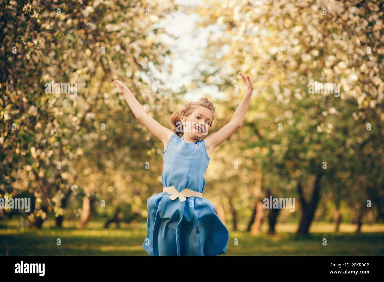 Happy child running and jumping in the park Stock Photo - Alamy