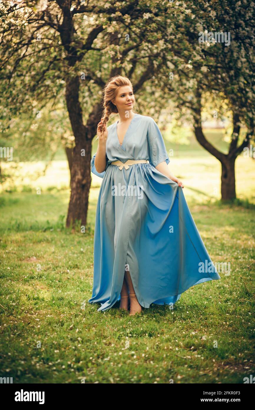attractive woman walking in spring park alone Stock Photo - Alamy