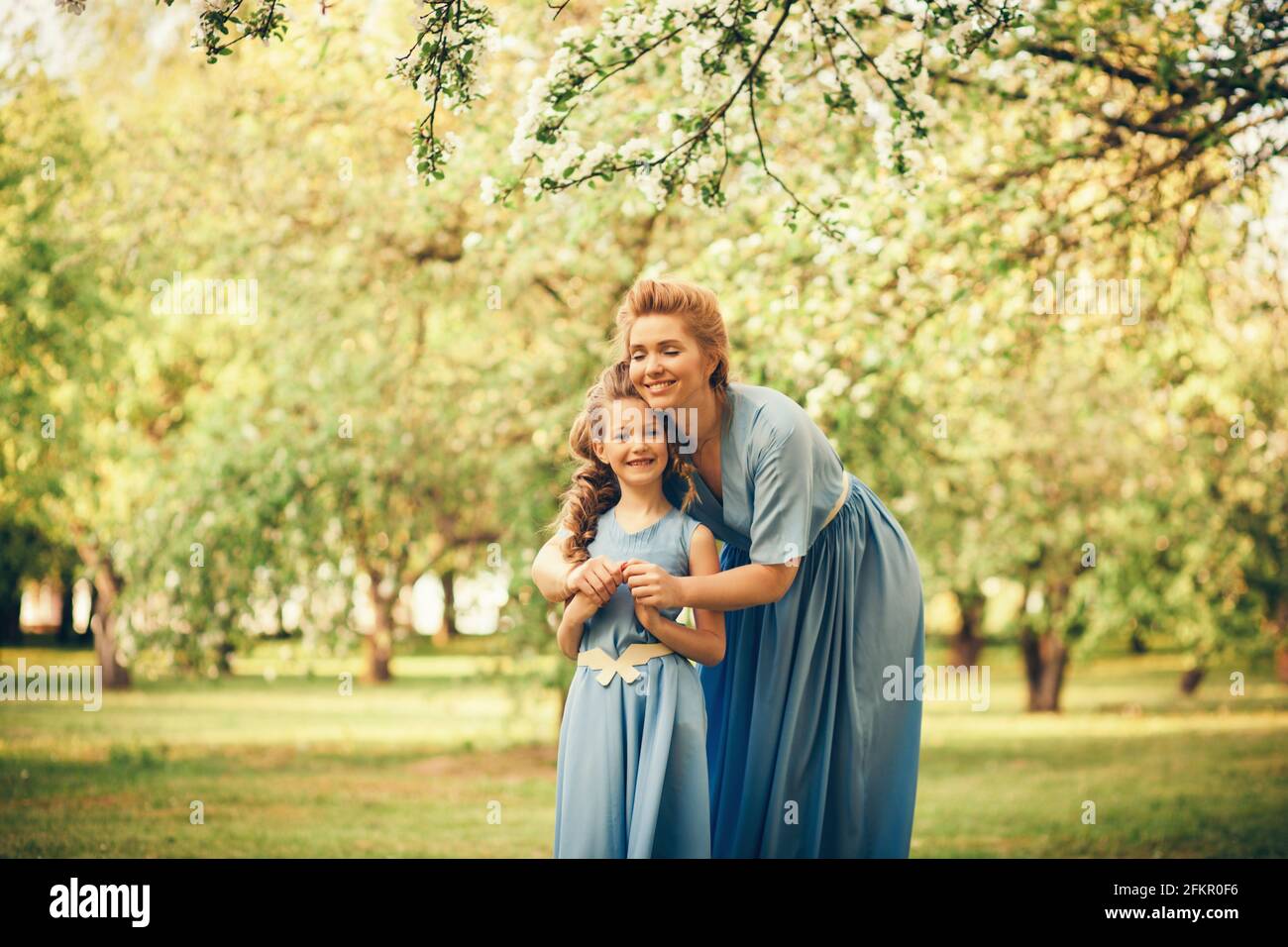 Mother and daughter together in a blossoming garden Stock Photo - Alamy