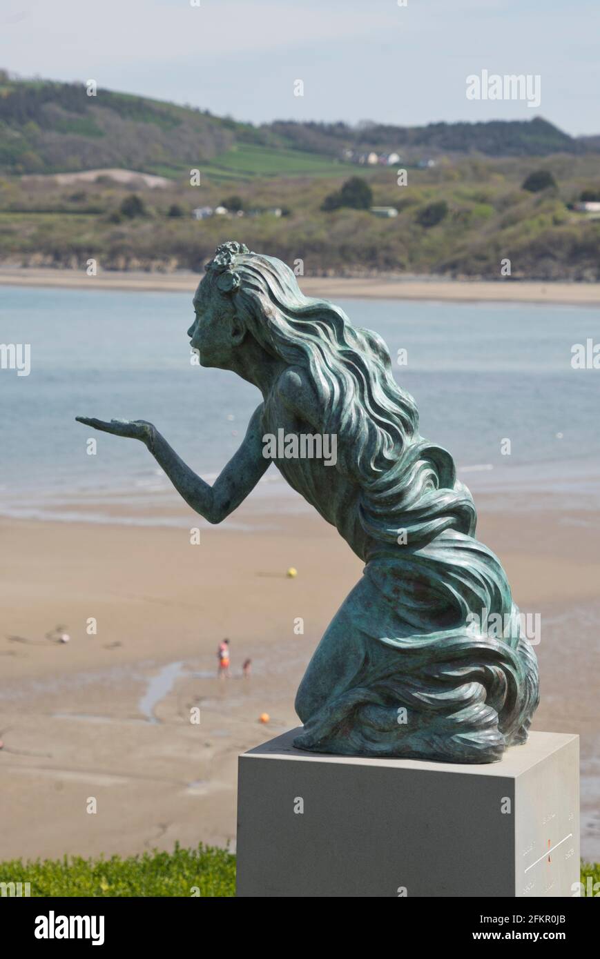 Visitors by mermaid statue on the beach in the harbour of the coastal ...