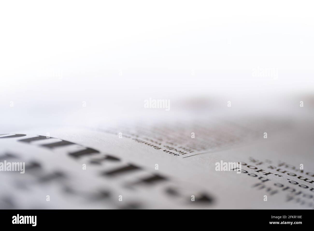 Newspaper with header and text, lying on a table and photographed from ...