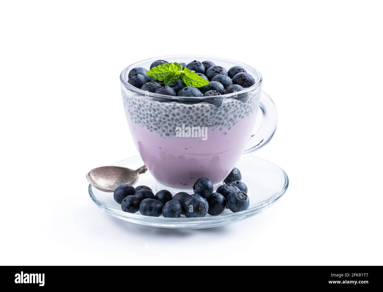 Purple blueberry yogurt with fresh berries chia seeds in glass cup ...