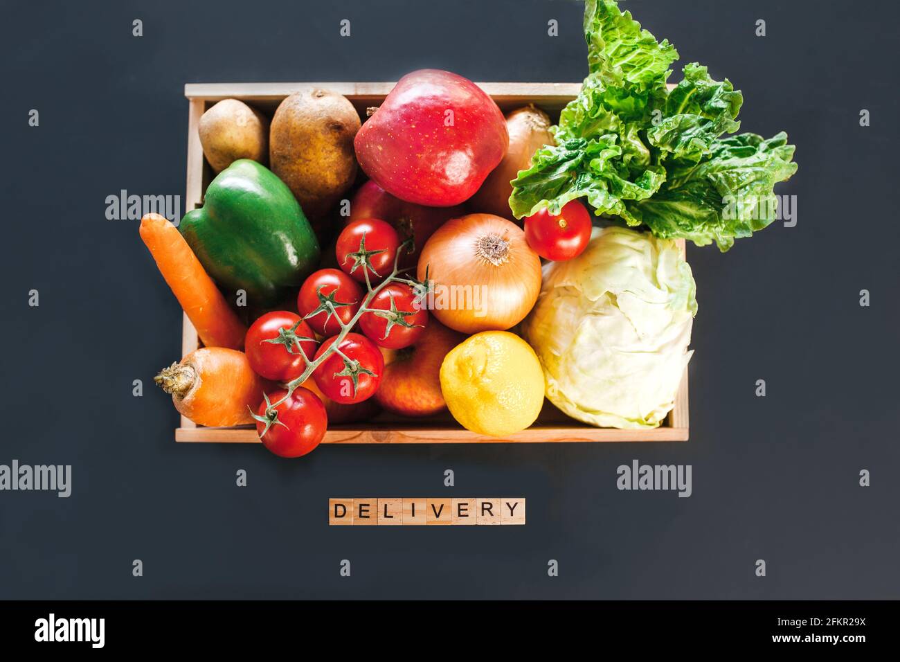 Fresh produce donation box on black background Stock Photo - Alamy