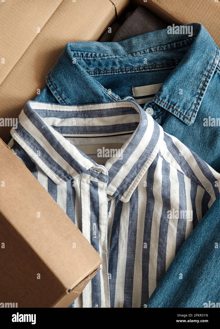 Overhead view at card box with clothes inside Stock Photo - Alamy