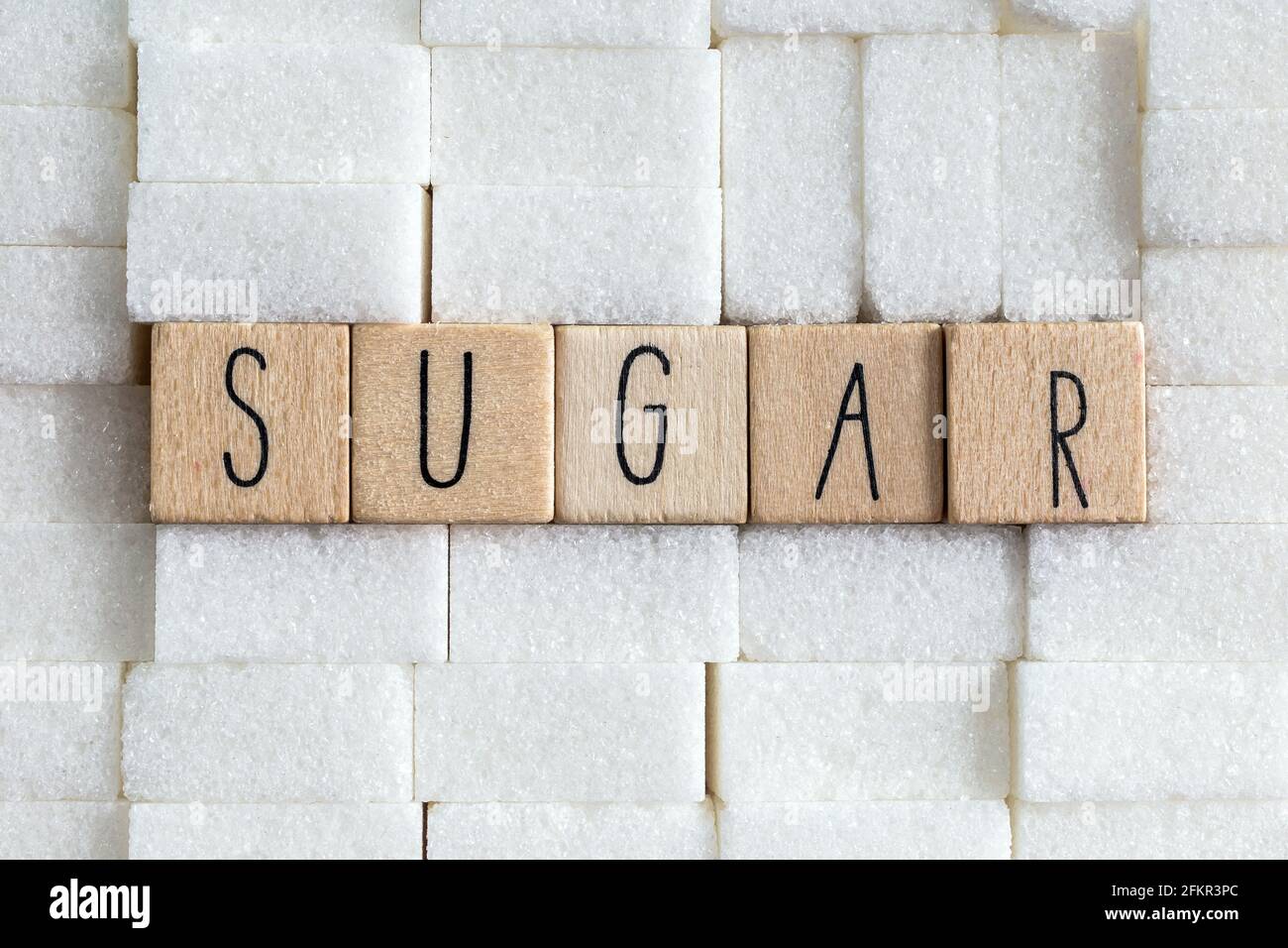 Sugar cubes wall with the text Sugar on brown natural background ...