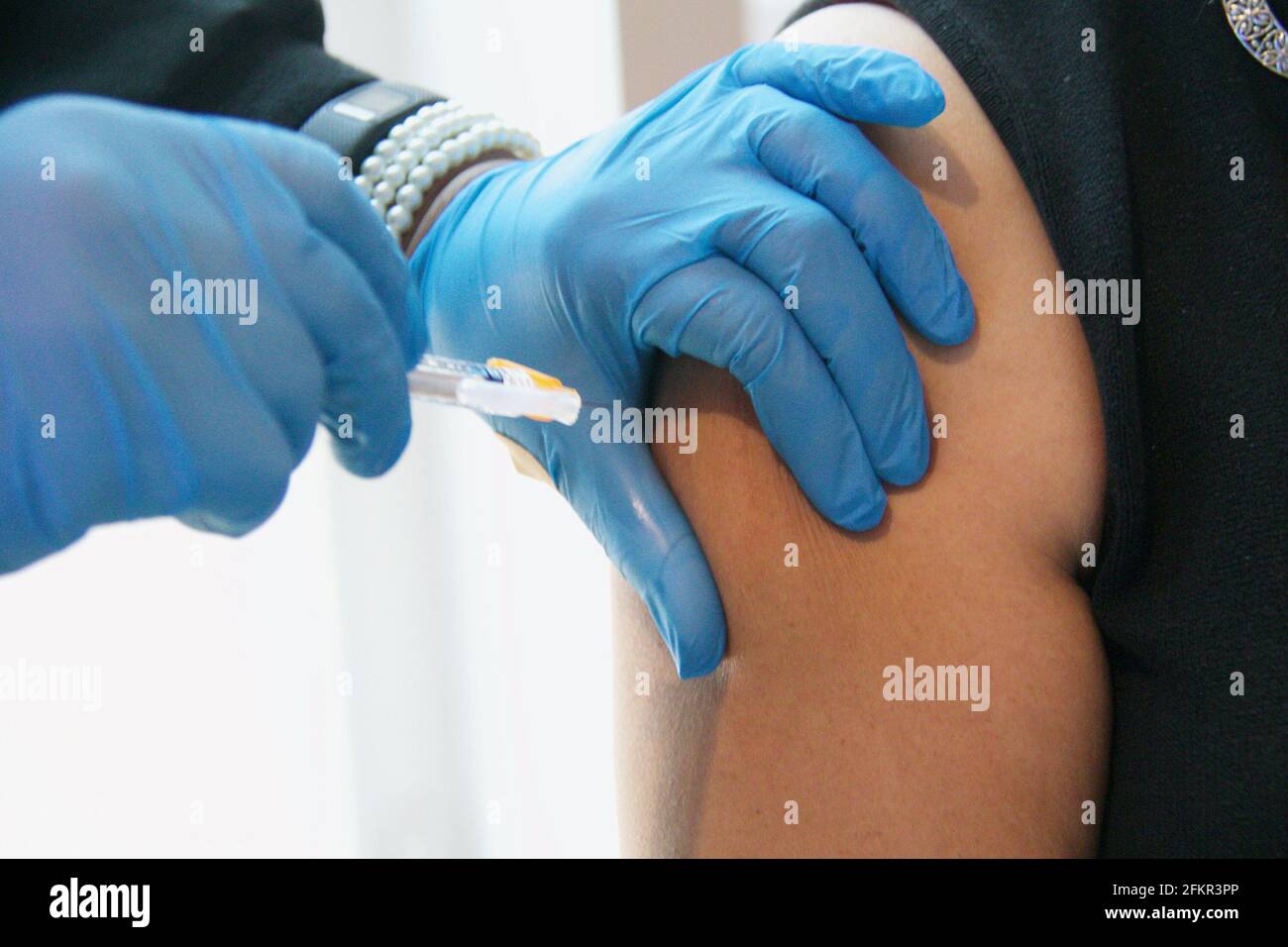 Shallow focus shot of a female getting vaccinated Stock Photo - Alamy
