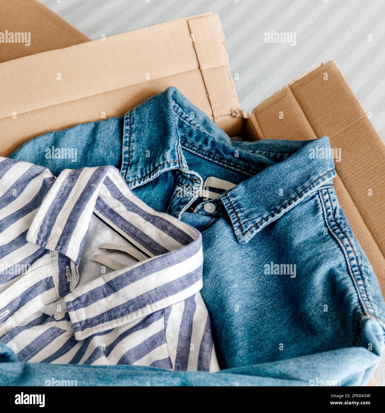Overhead view at card box with clothes inside Stock Photo - Alamy