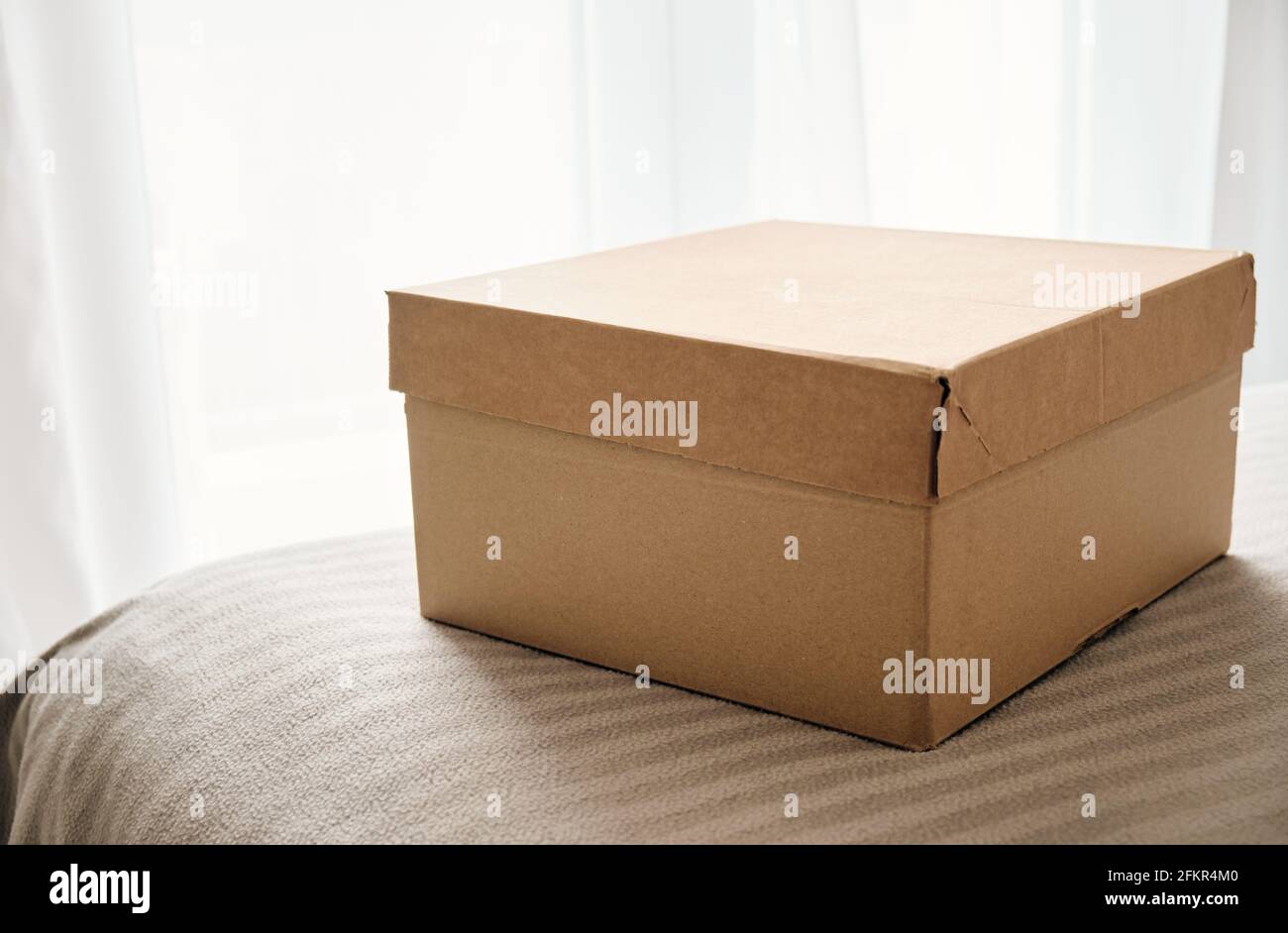 Cardboard box on the bed Stock Photo - Alamy