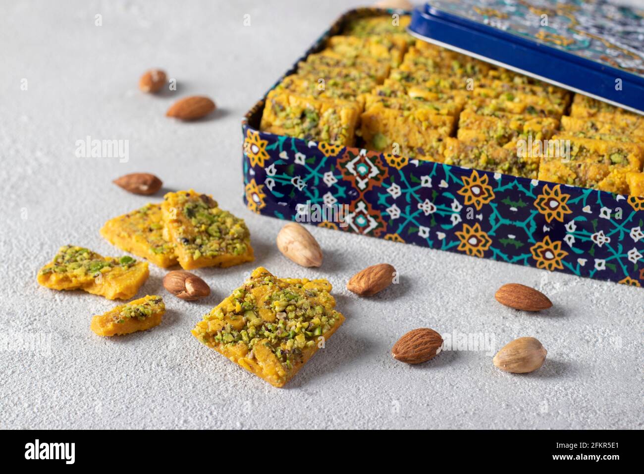 Traditional Persian dessert Sohan from Iran in box on gray background ...
