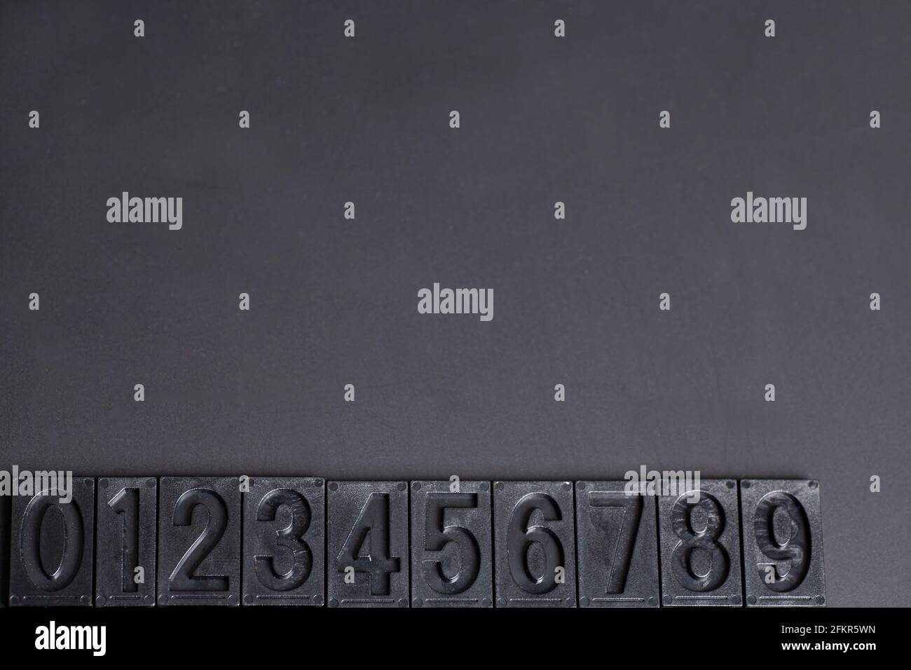 letterpress numbers on black background Stock Photo - Alamy