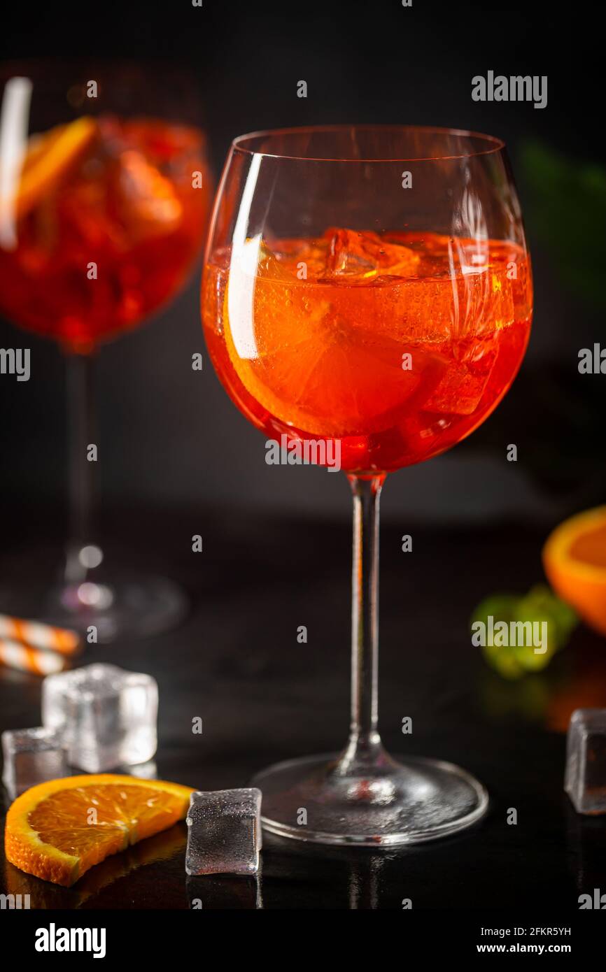 Aperol spritz cocktail in glass with fresh orange on dark background ...