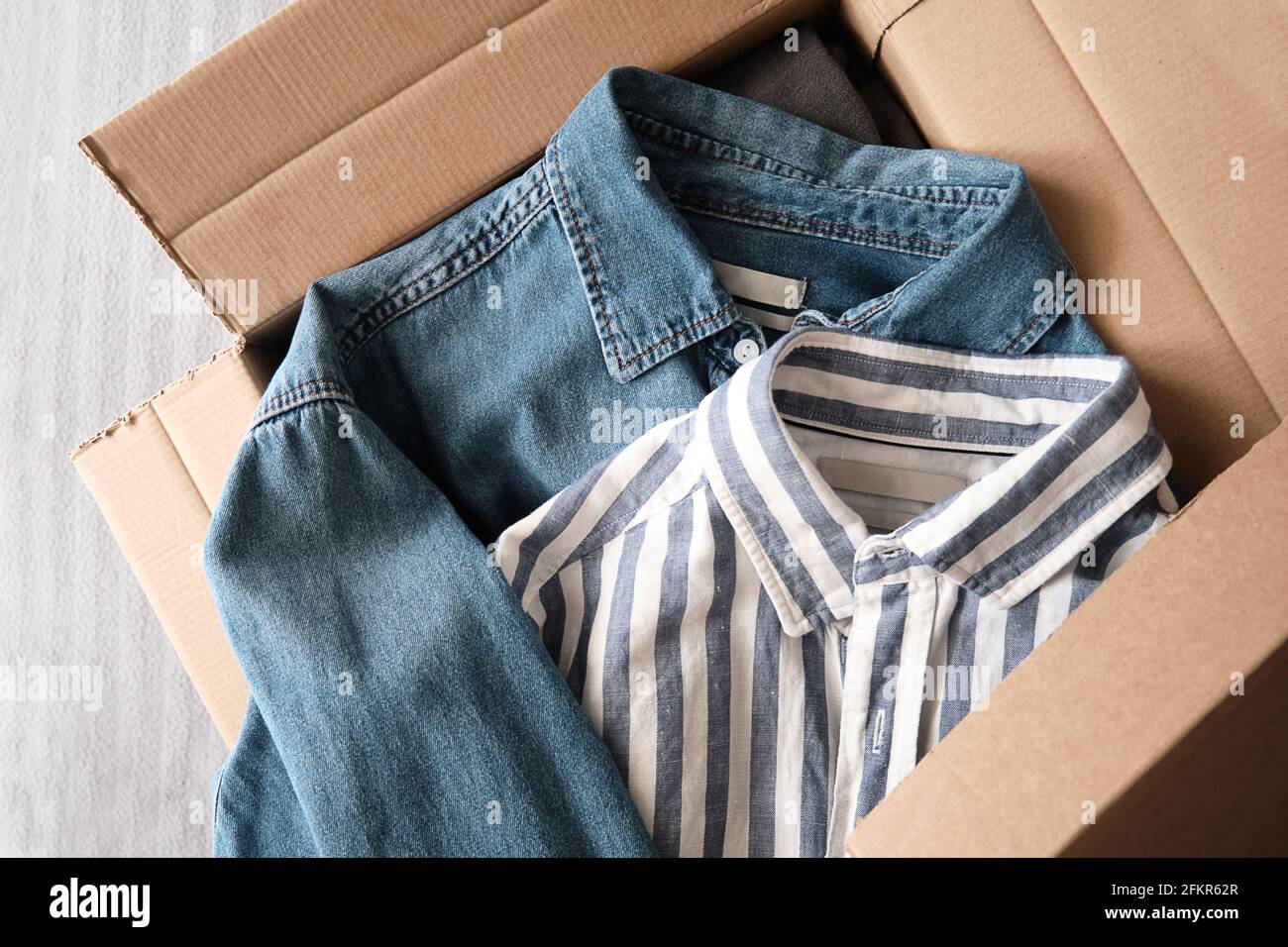 Card box with clothes inside. Sustainable fashion, Clothing swap Stock ...