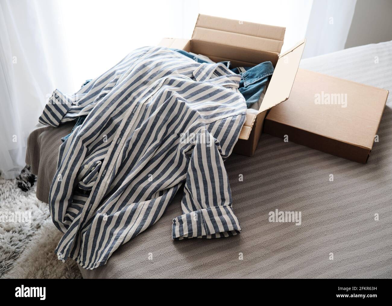 Card box with clothes inside. Sustainable fashion, Clothing swap Stock ...