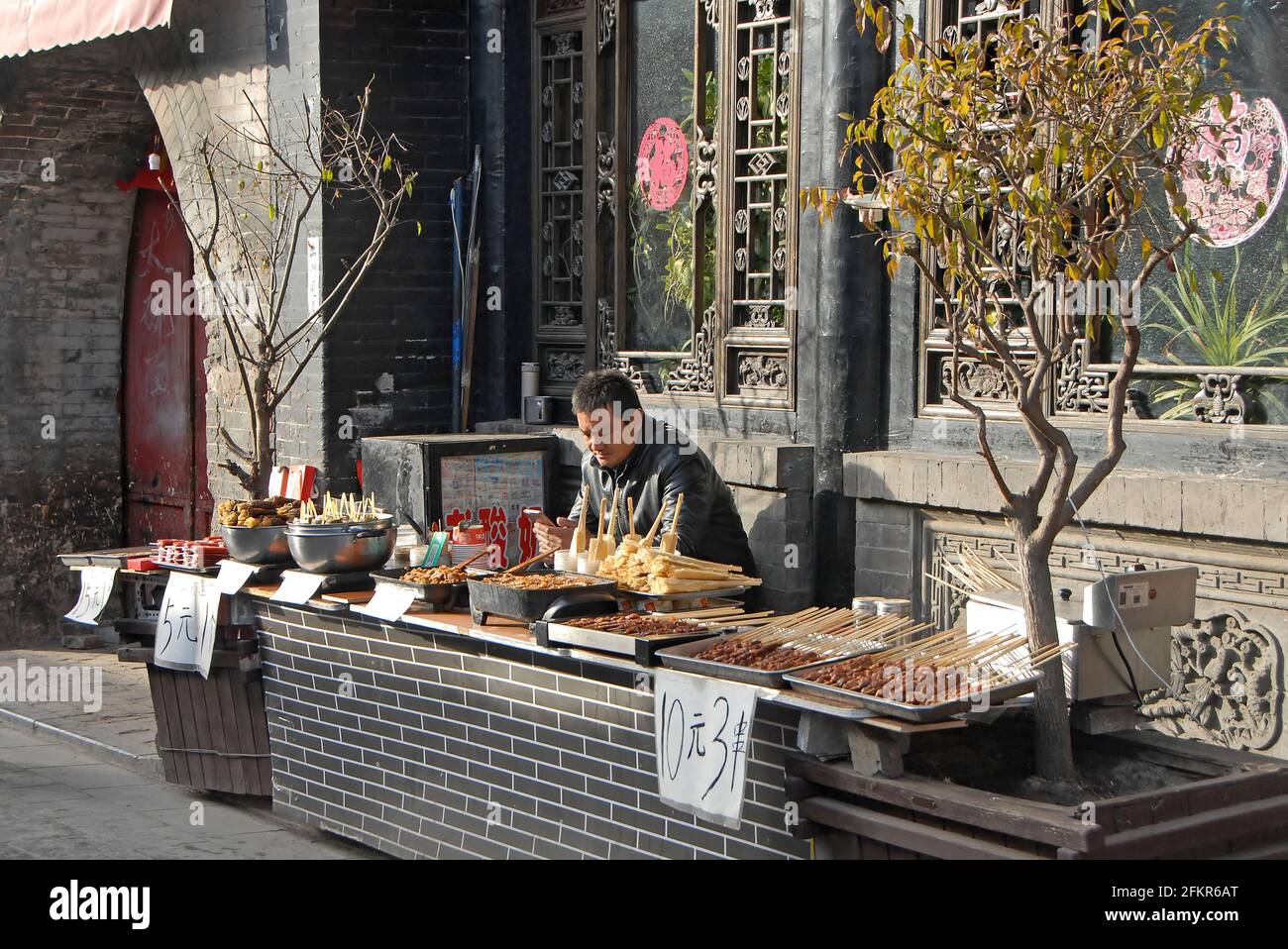 Pingyao in Shanxi Province, China: A vendor selling street food in ...
