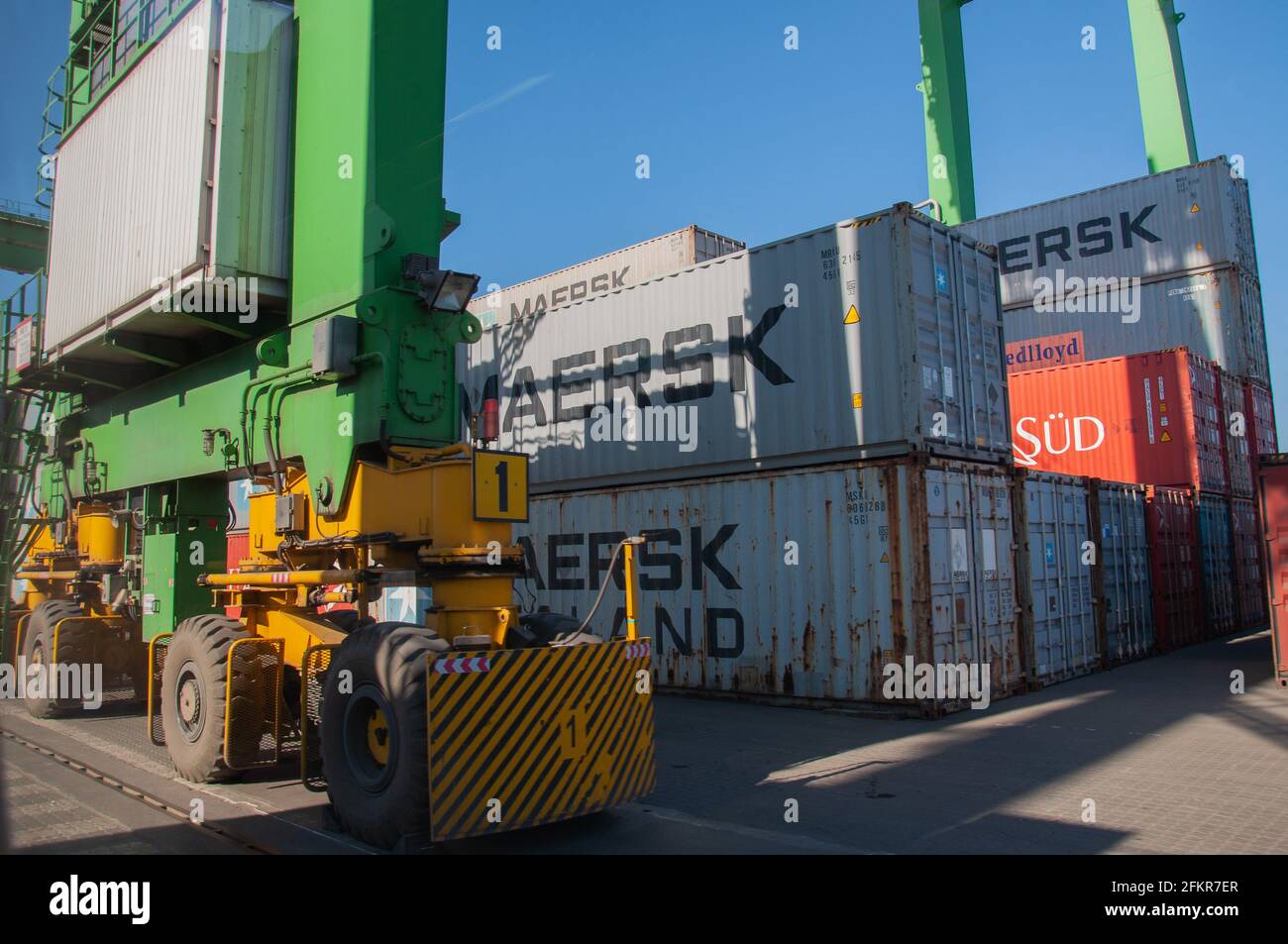 Container terminal of TIS Group dry cargo port. Maersk containers under container loader heavy ...