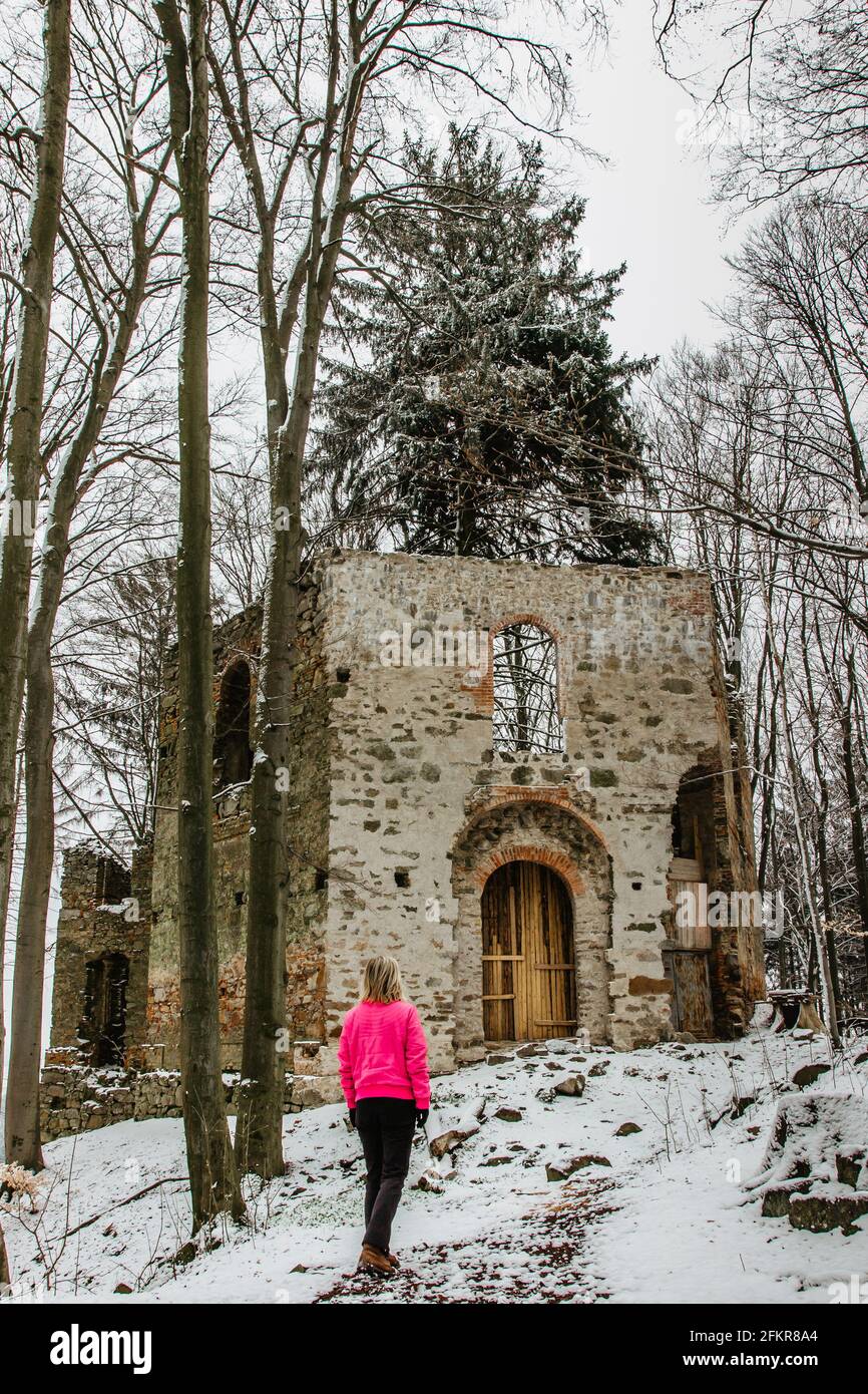 Hiking girl enjoying view of ruins of abandoned Chapel of Saint Mary ...