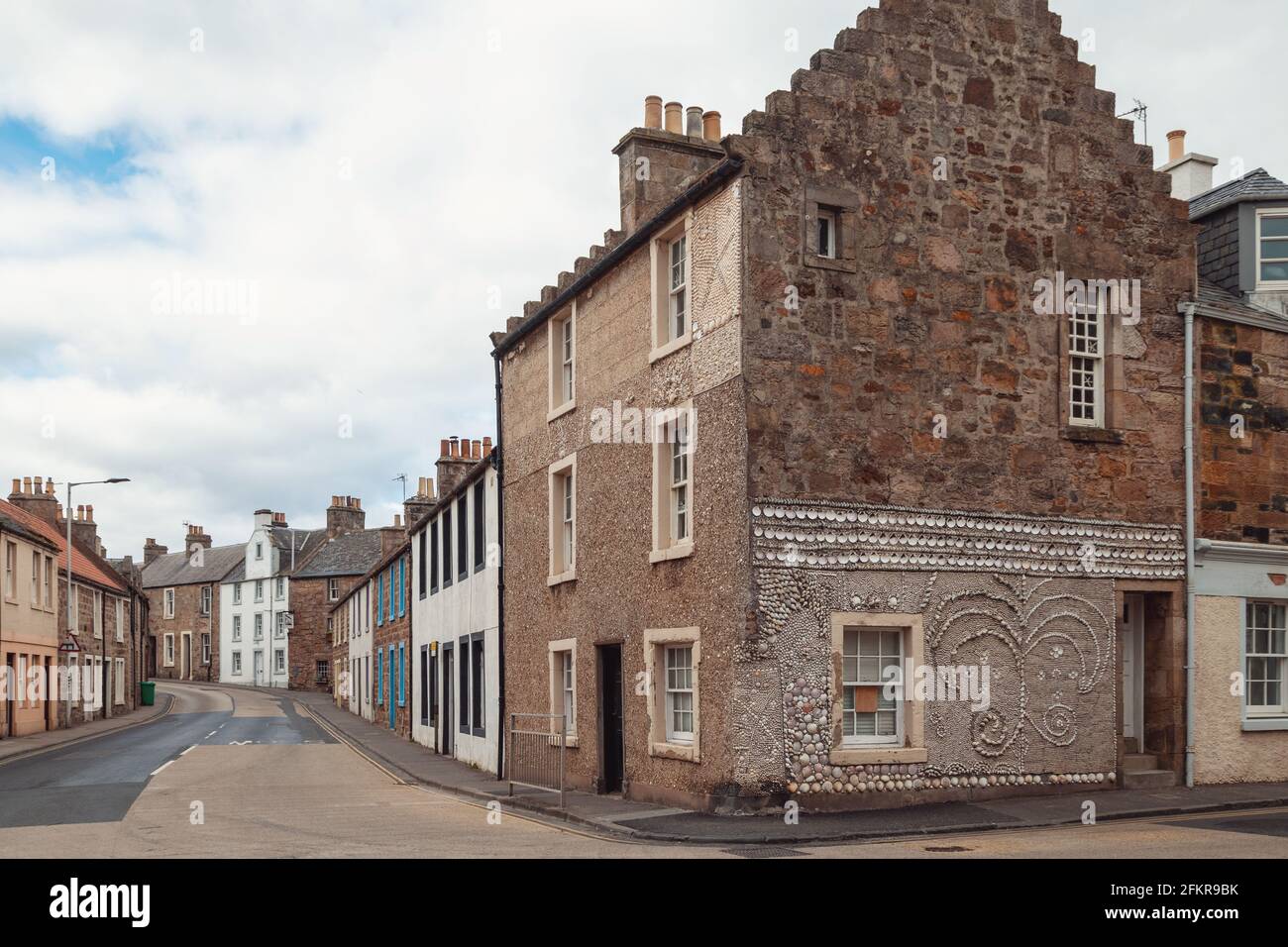 A house in Anstruther decorated with sea shells in the wall of the ...