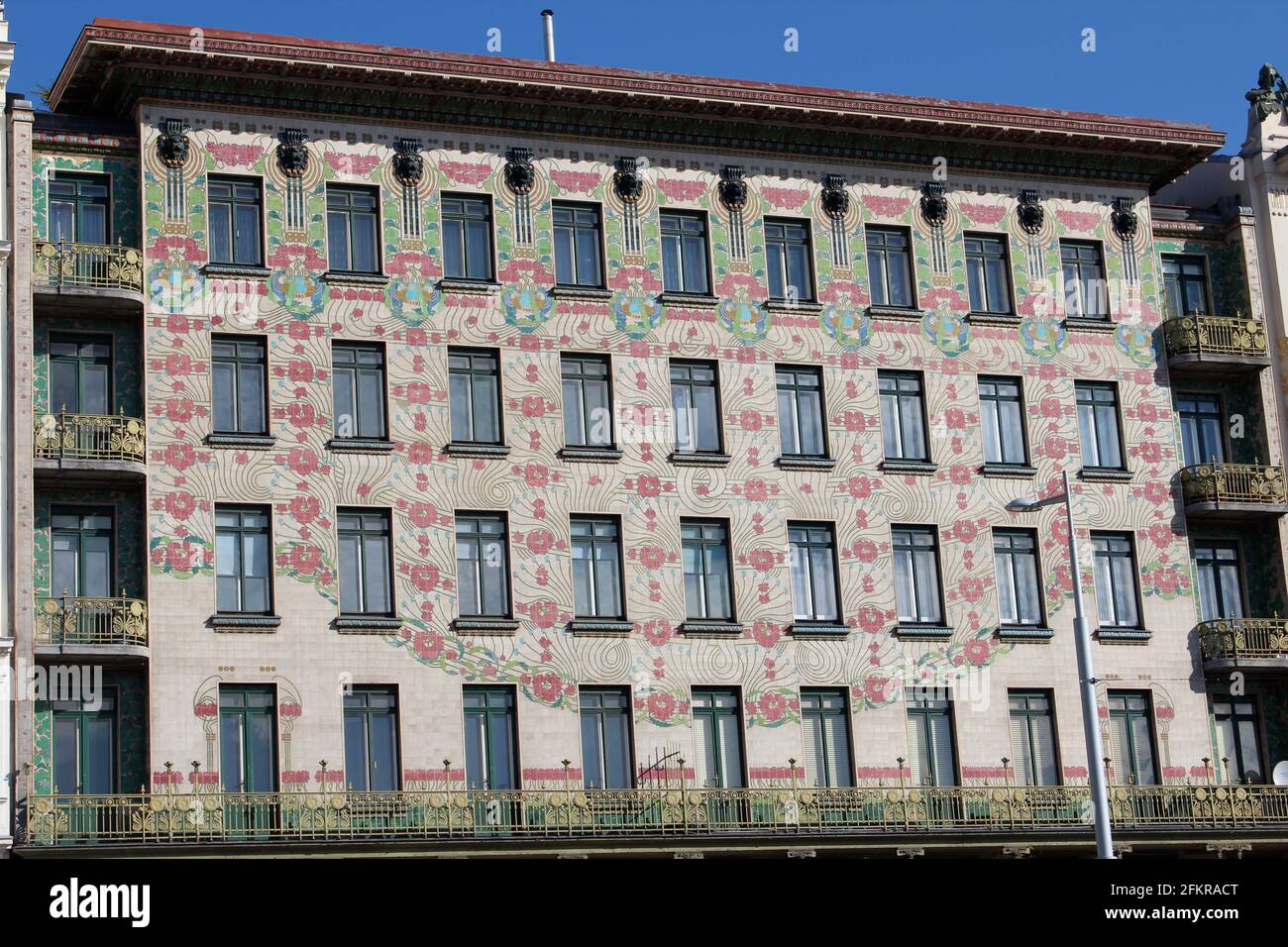Intricate painted facade of building in Vienna, Austria. Pink and green ...