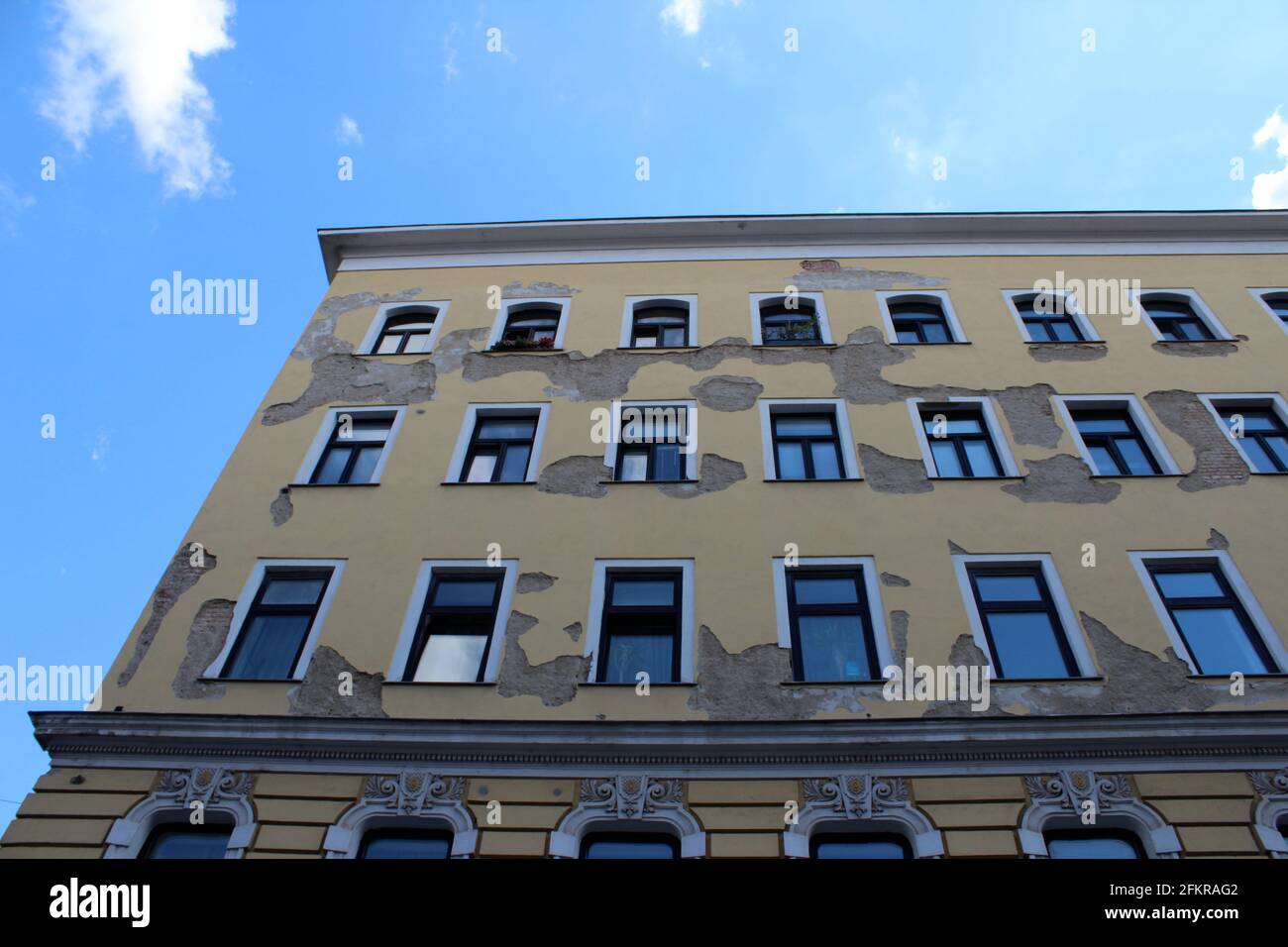 Old yellow building in Vienna, Austria whose facade is falling away ...