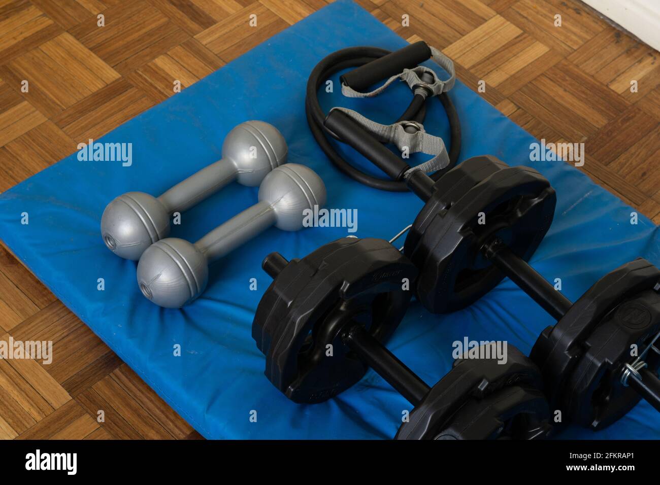 Dumbbells on a mat on the floor of the house gym Stock Photo - Alamy