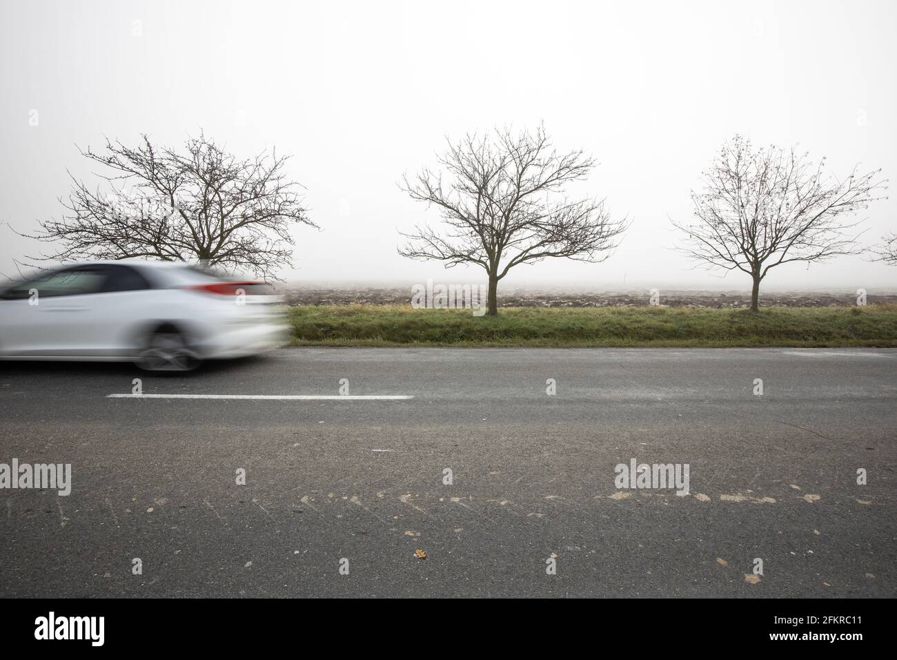 Motion blurred car going fast on a rural road Stock Photo - Alamy