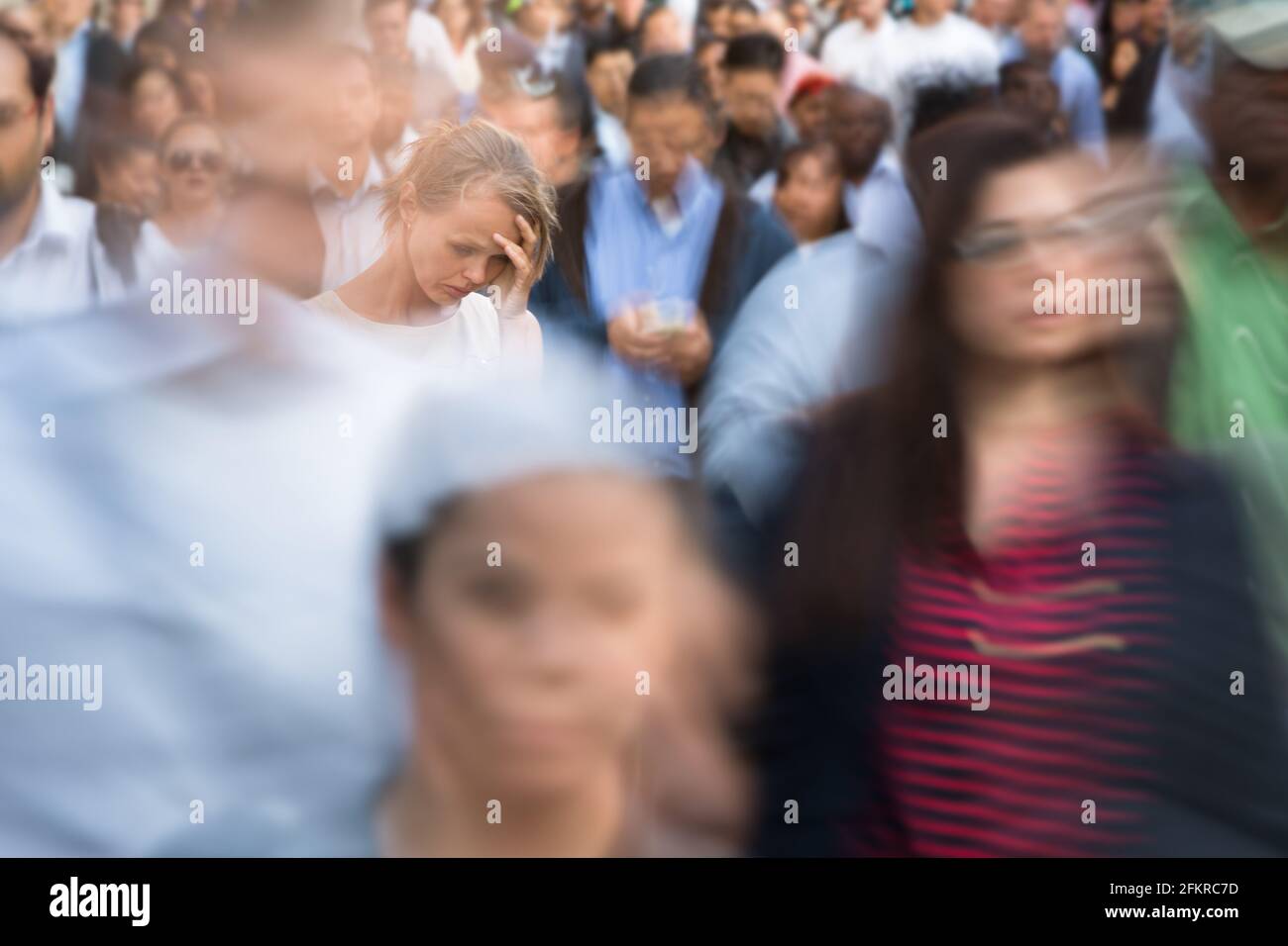 Crowd of people walking on city street - motion blurred image with ...
