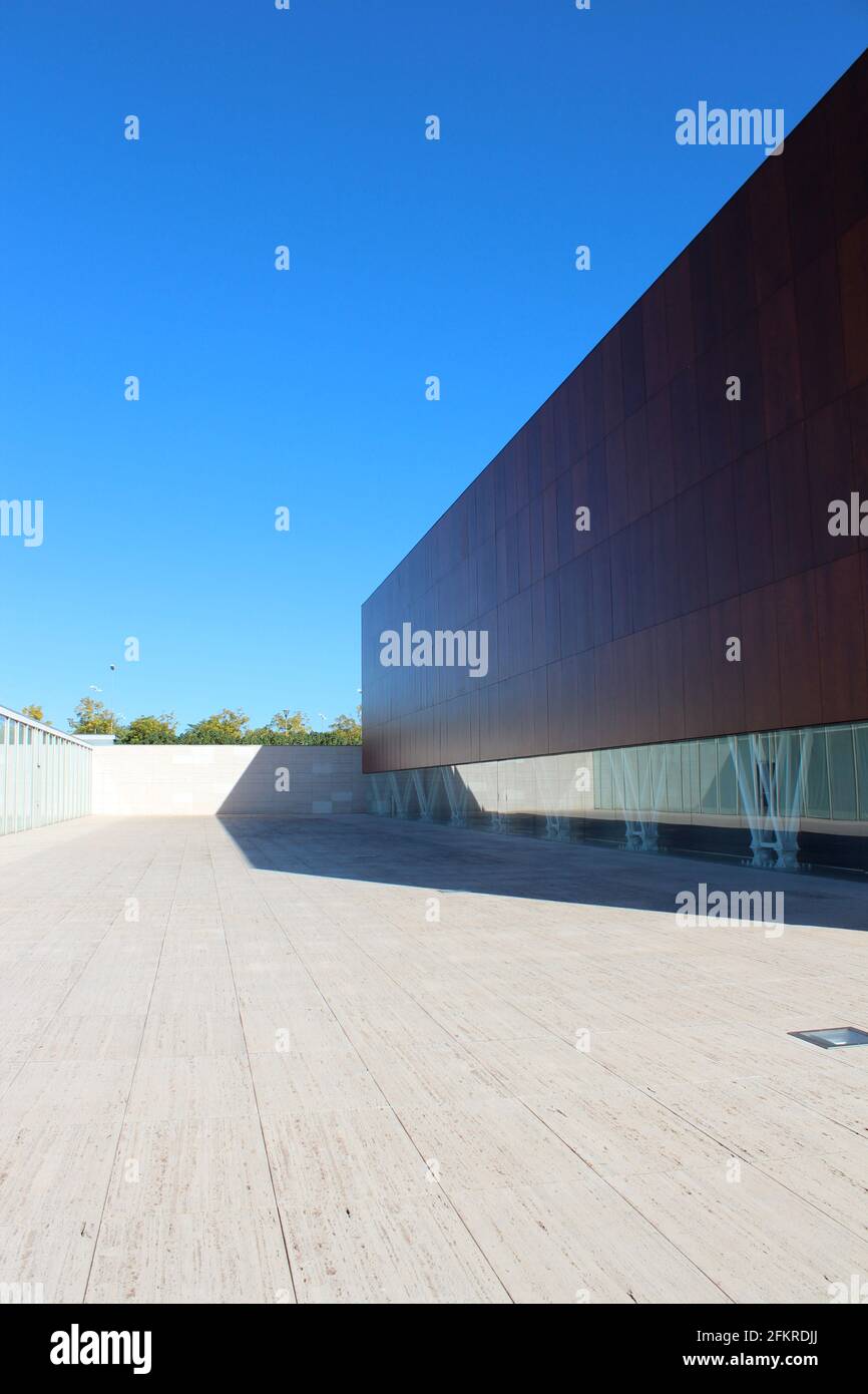 Modern building sunk in to courtyard with corten steel facade and glass ...