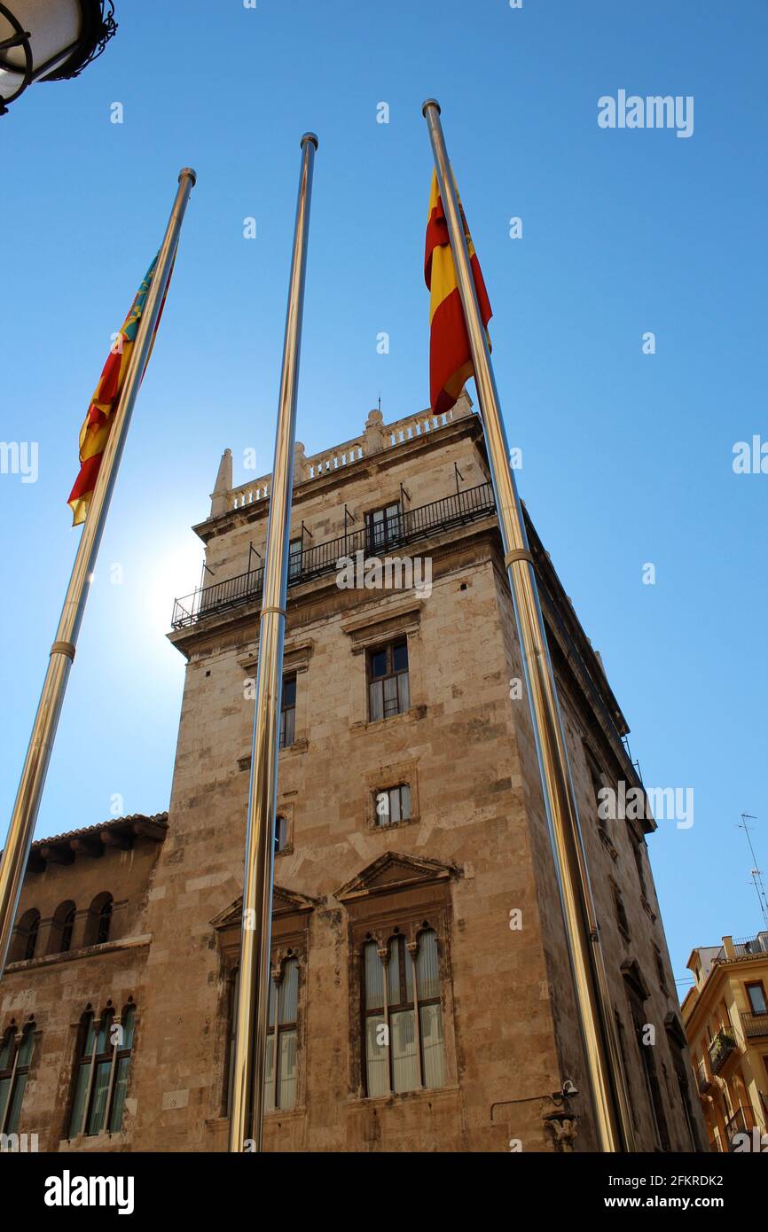 Sun peeking out behind historic red stone building in Spain as seen ...