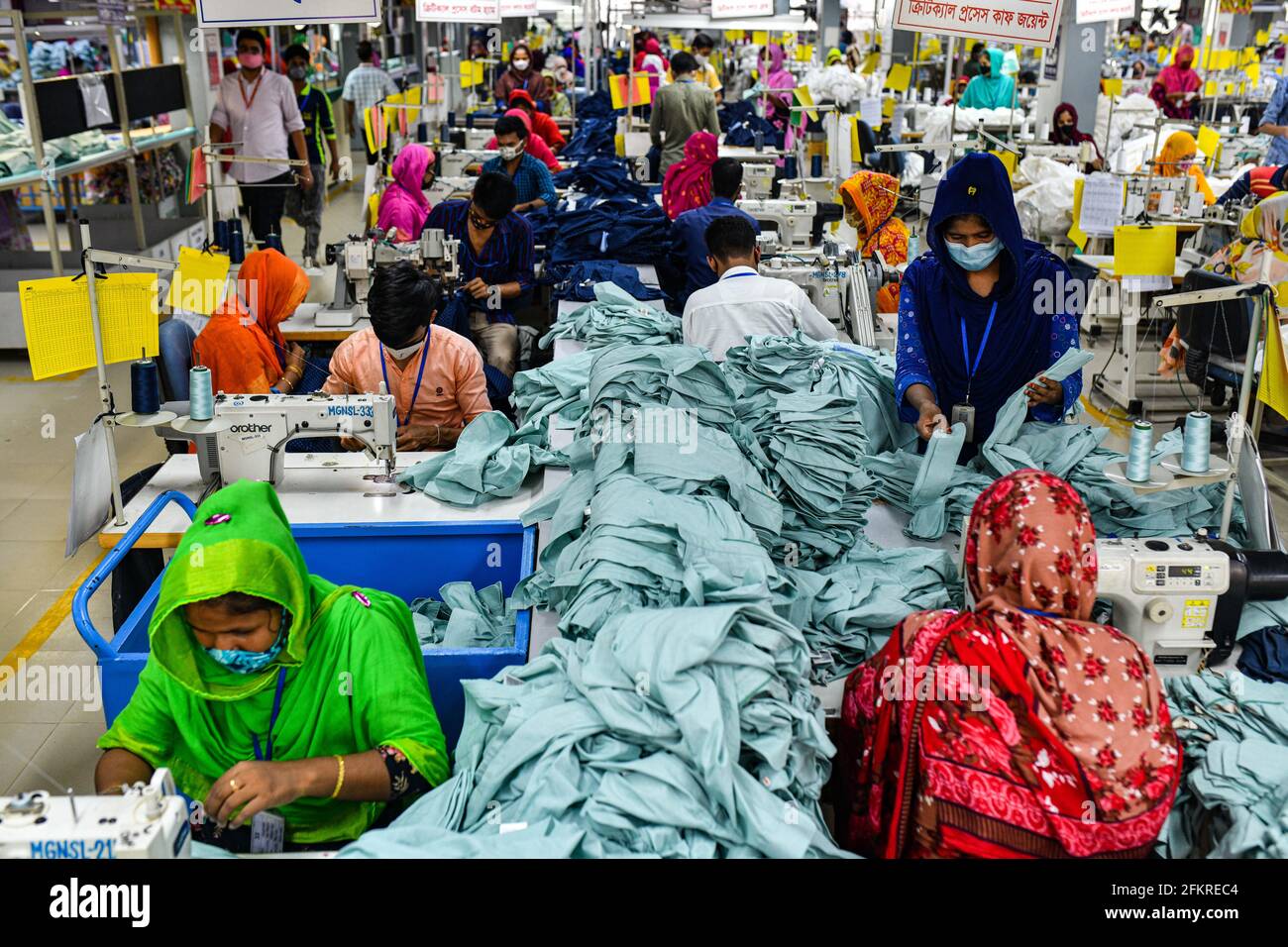 Garment workers work in a sewing section of the MG Niche Stitch Limited ...