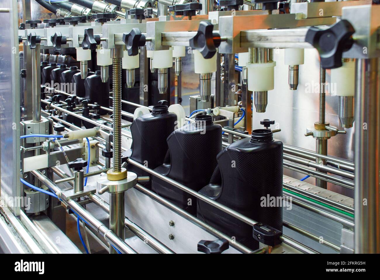 The bottles are transferred on the conveyor belt system. Industrial ...