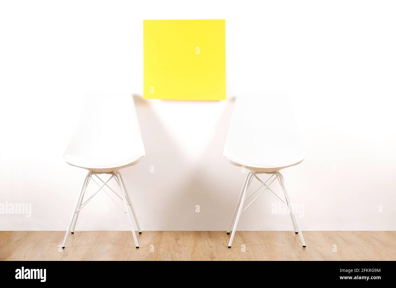 Pair of seats, two empty loft style chairs on wooden floor with blank ...