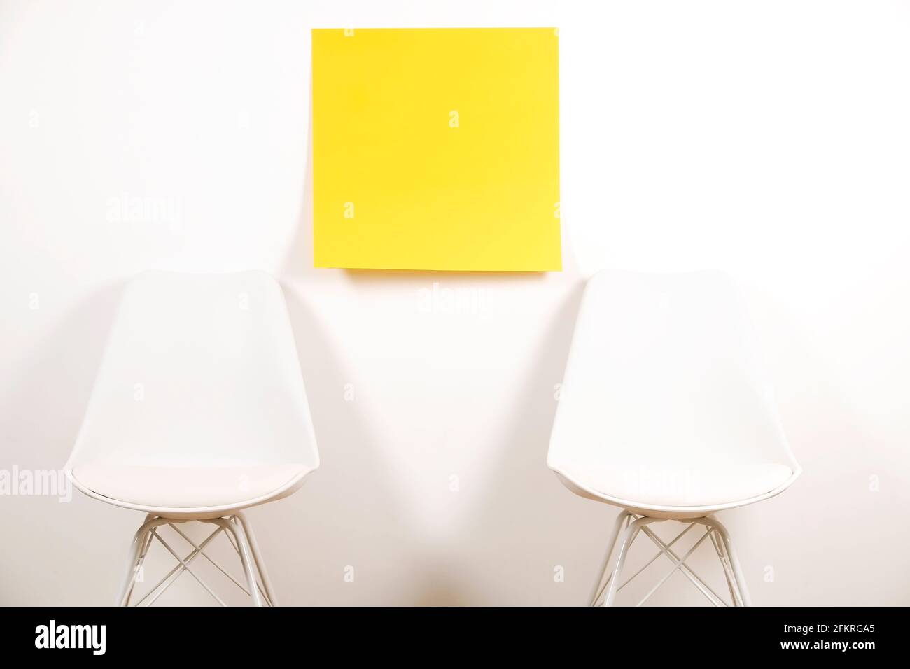 Pair of seats, two empty loft style chairs on wooden floor with blank ...