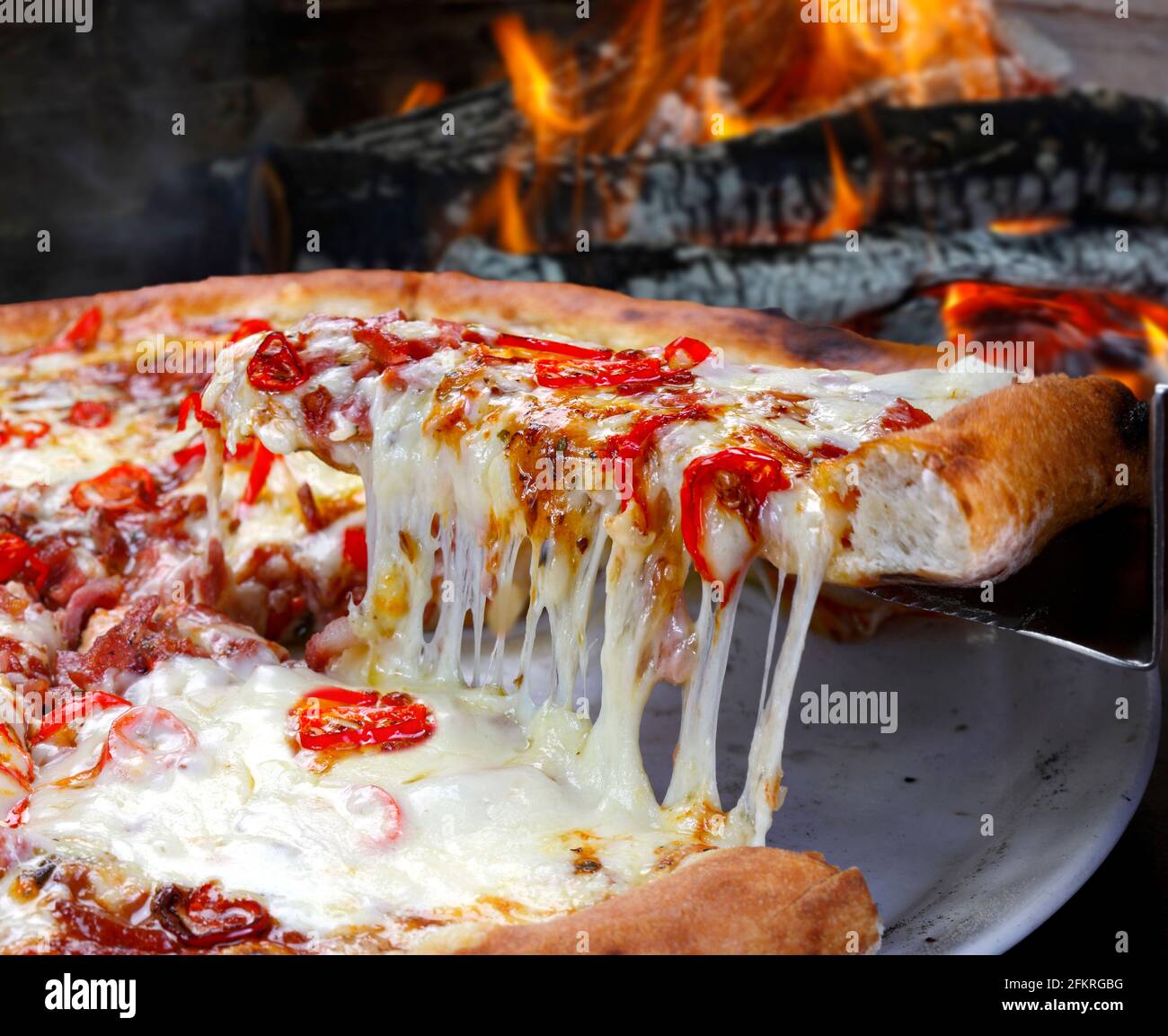 Slice of melting mozzarella pizza Stock Photo - Alamy