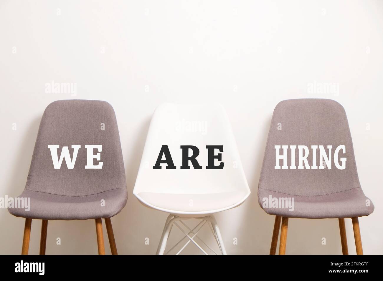 Job recruitment advertisement, WE ARE HIRING text written on three ...