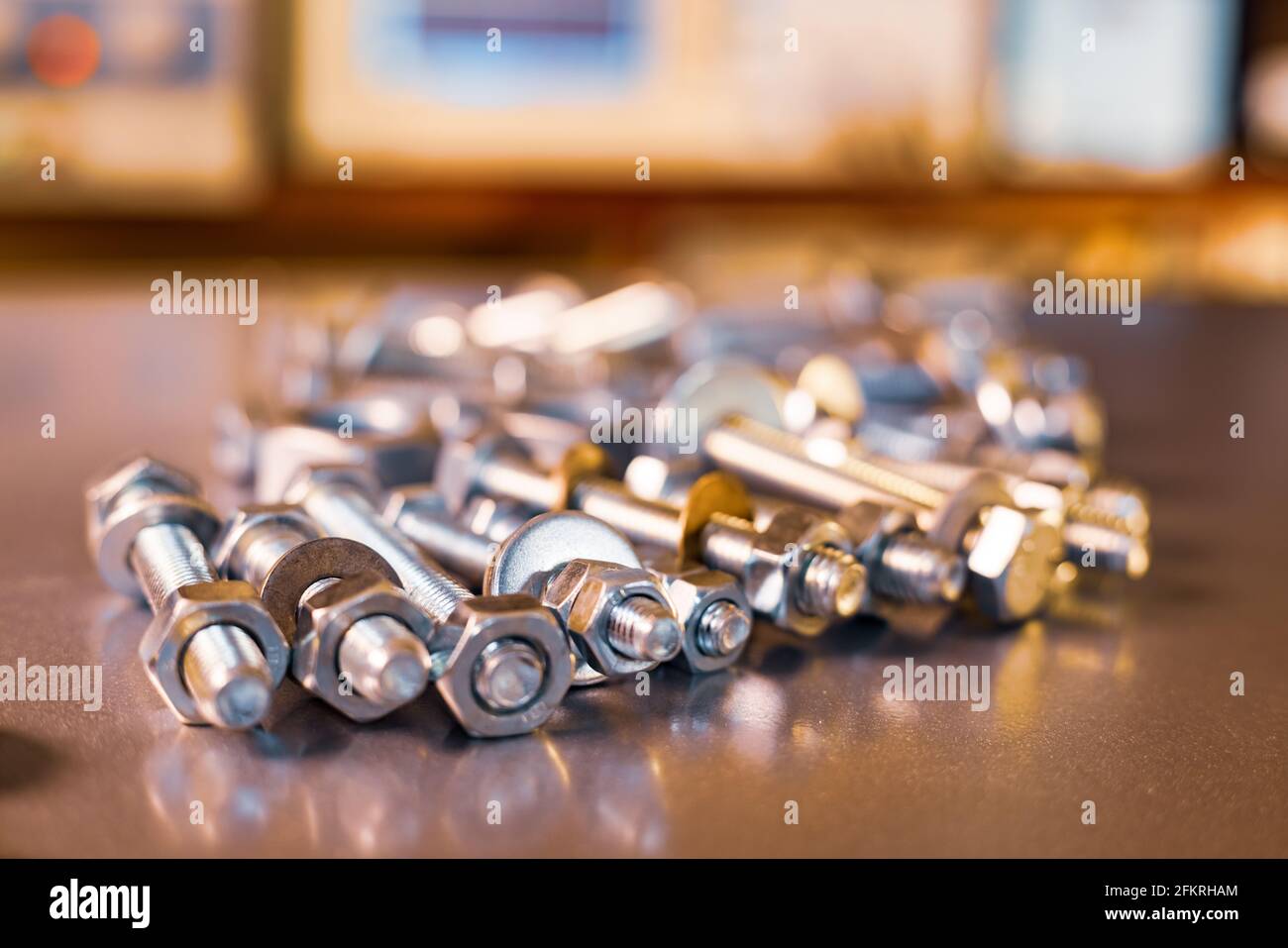 Close-up metal chrome bolts and nuts in a chaotic order. Background ...