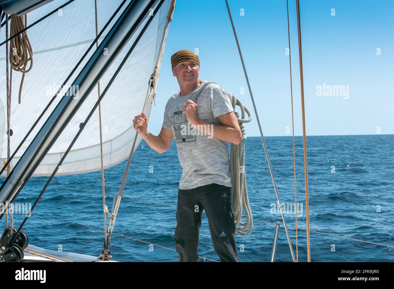 A man on board a sailing yacht at sea. Yachting. Active lifestyle ...