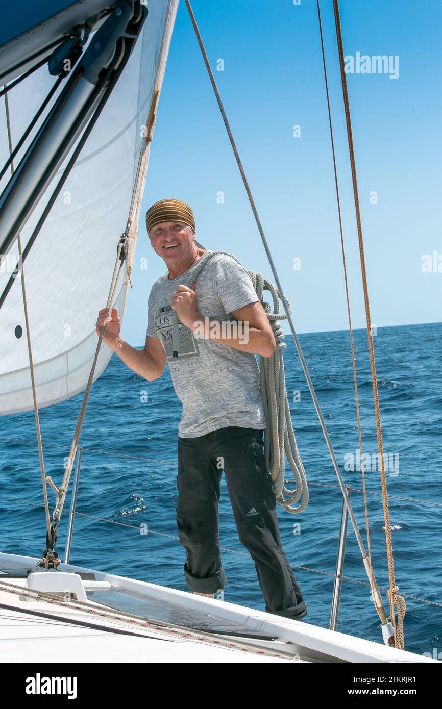 A man on board a sailing yacht at sea. Yachting. Active lifestyle ...