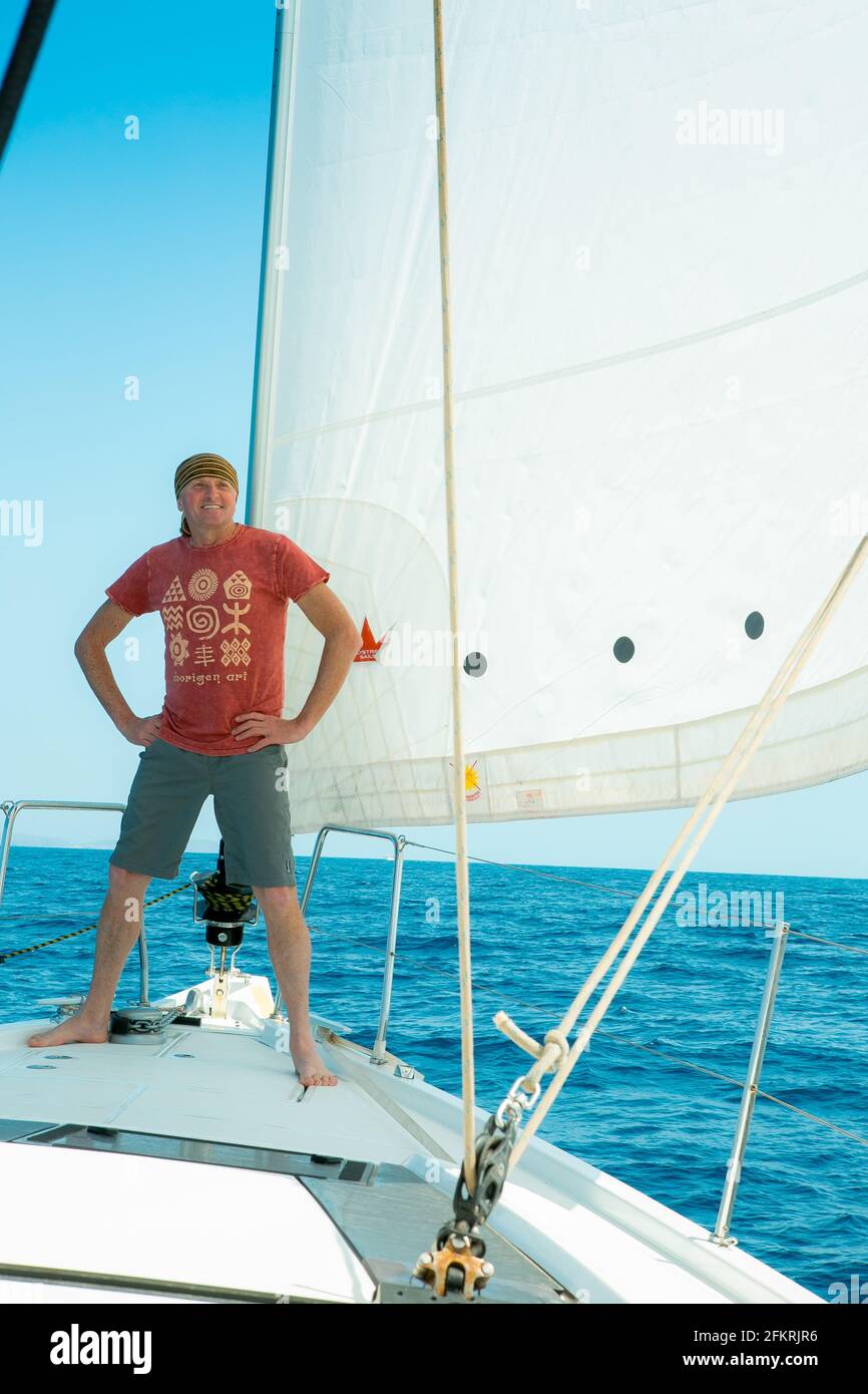 A man on board a sailing yacht at sea. Yachting. Active lifestyle ...