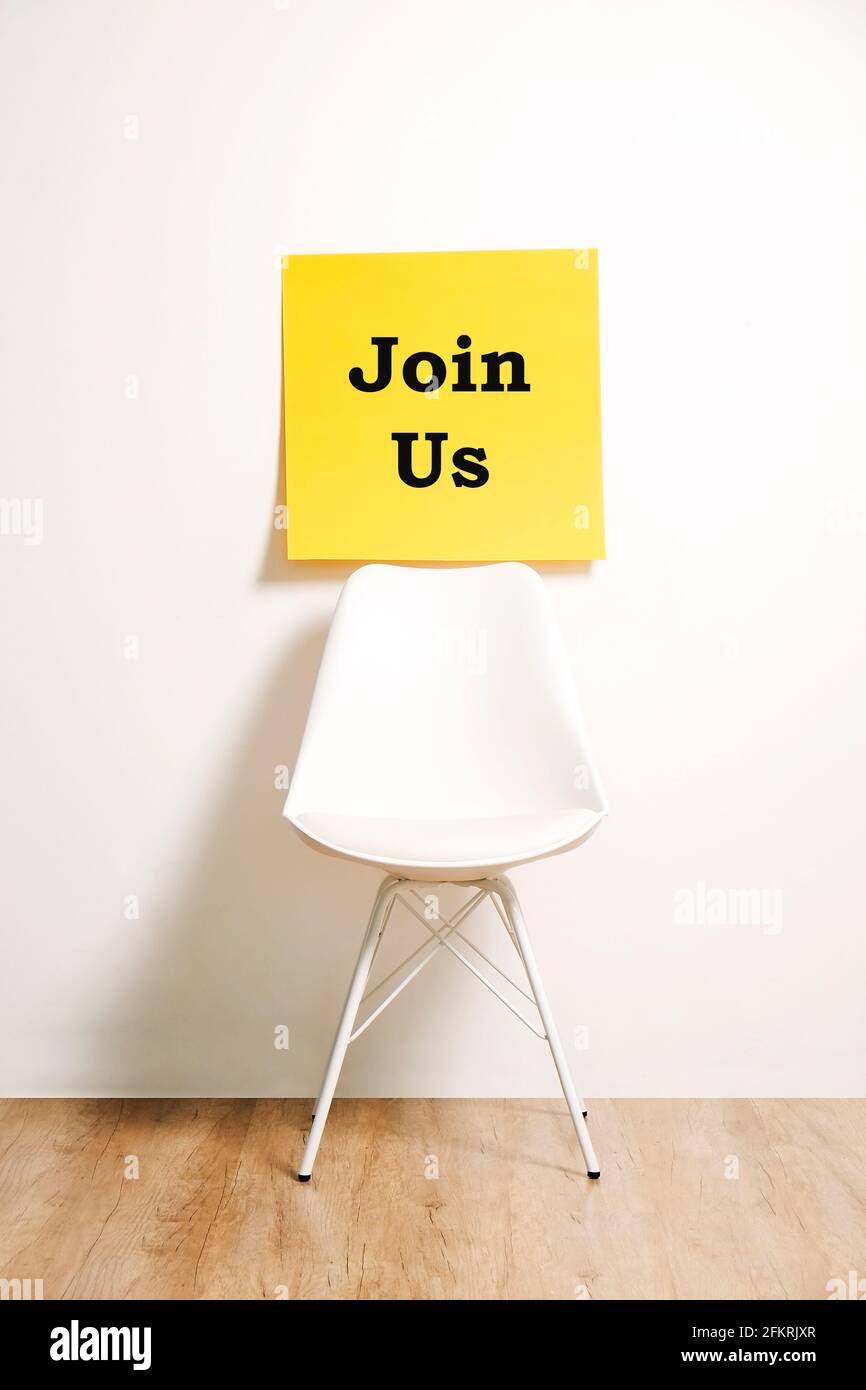 Job recruitment advertisement, JOIN US text written on yellow wall ...