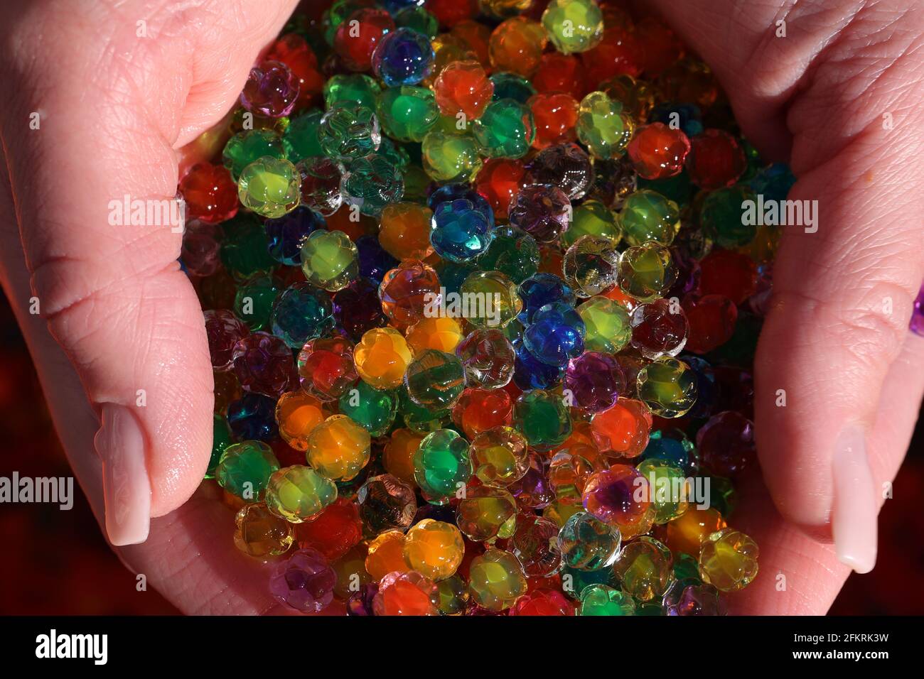 Female holding small colorful plastic balls in her hands Stock Photo ...