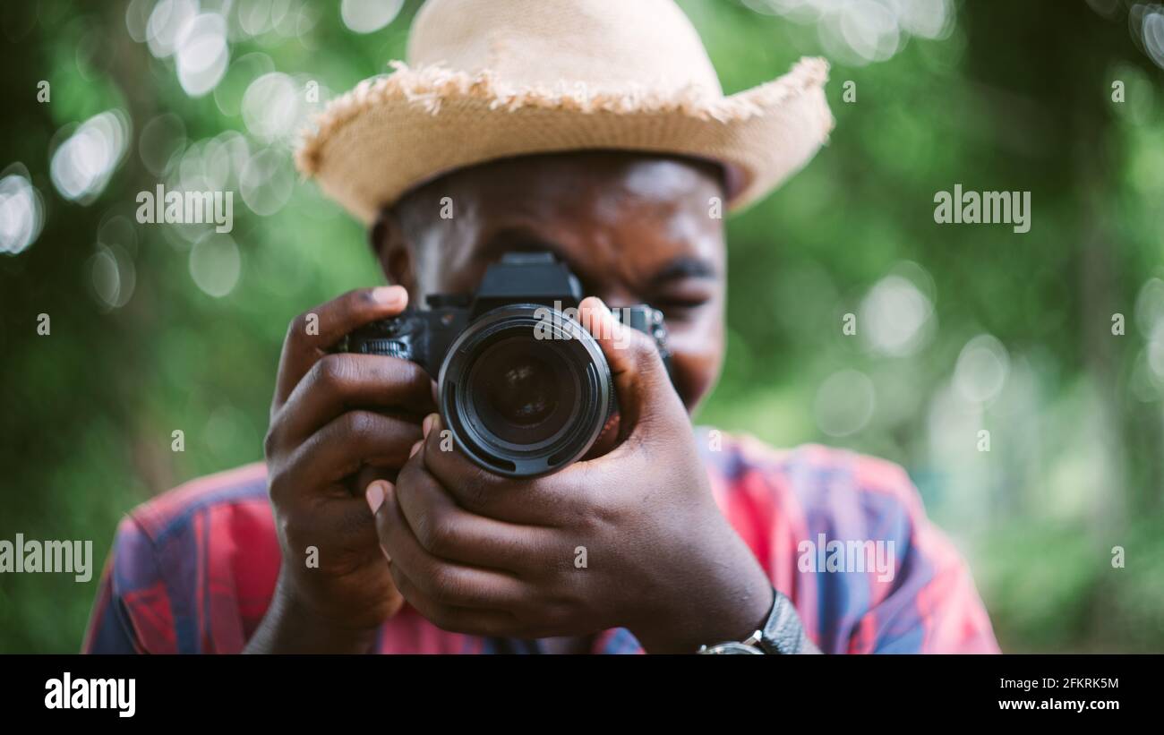 African man photographer takes pictures with the digital camera Stock ...