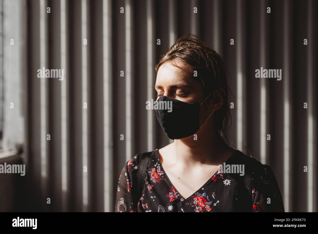 Depressed sad woman screaming and crying under mask for protection from ...