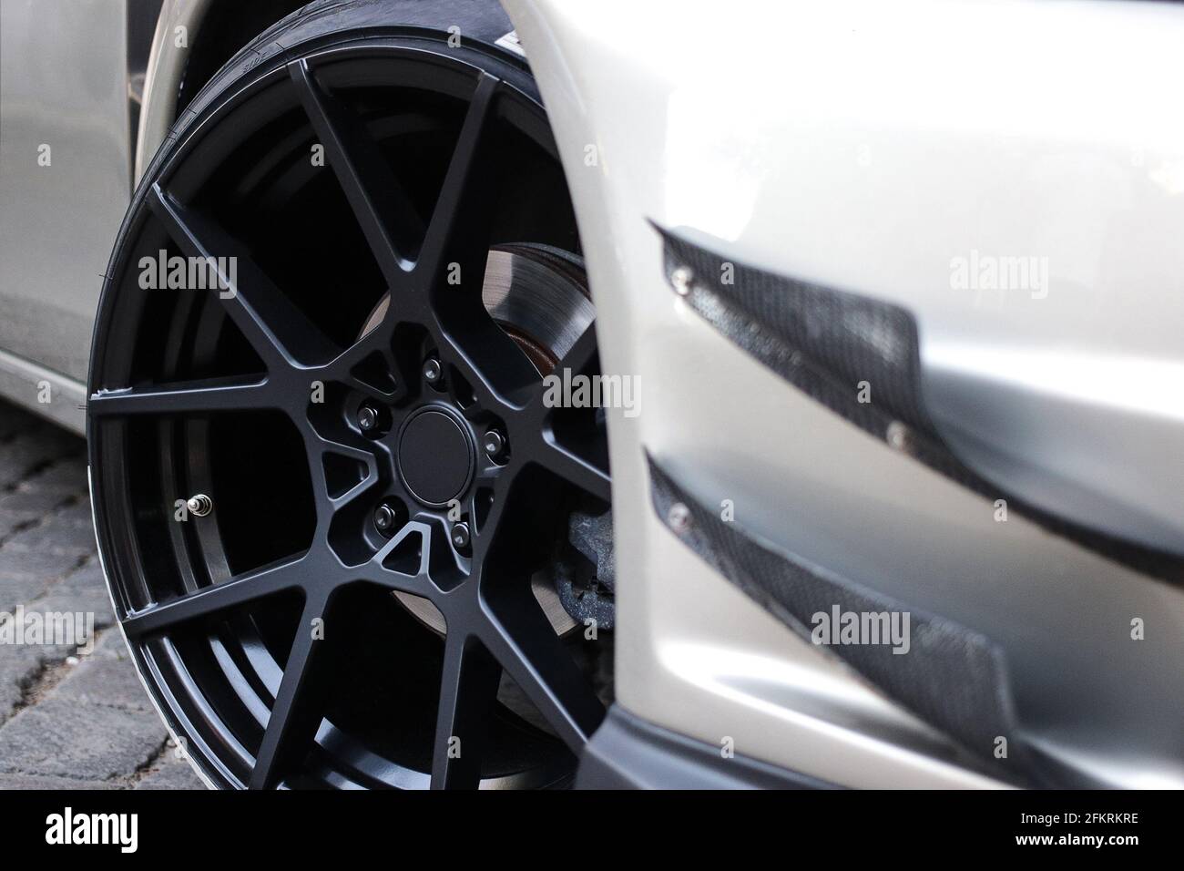 Close up of a wheel of a sports car. Black car rim with low profile ...