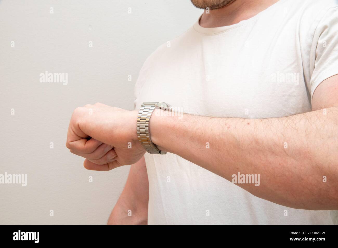 Closeup shot of a young male looking at his watch Stock Photo - Alamy