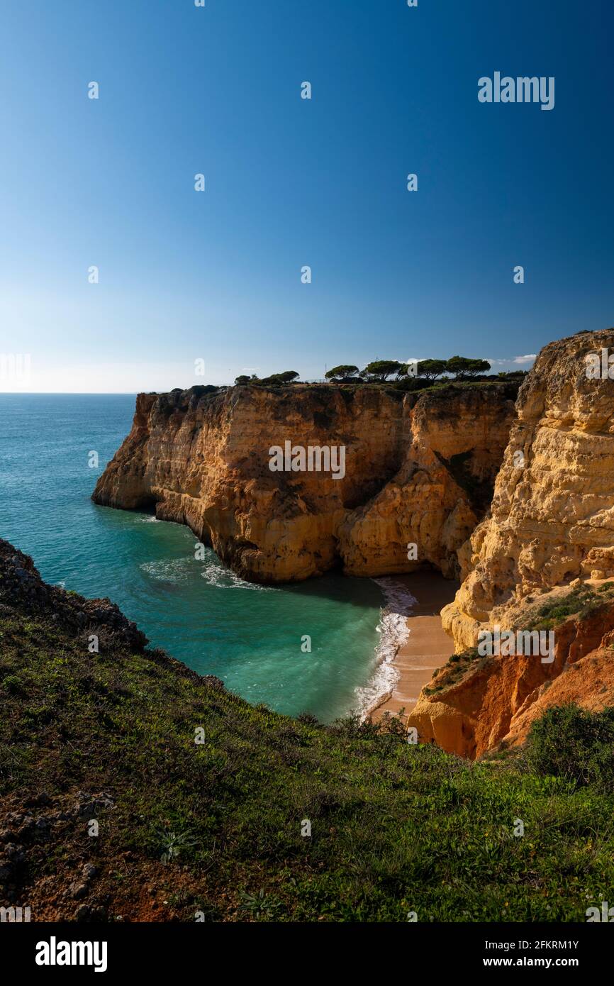 View of a small secluded beach surrounded by cliffs in Algarve ...