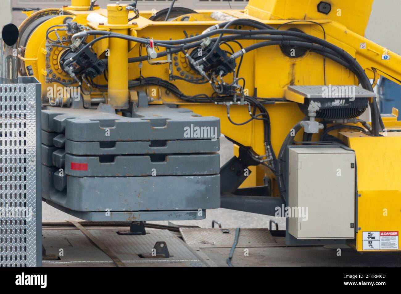 A fragment of hydraulic hoses and control tubes of the truck crane ...