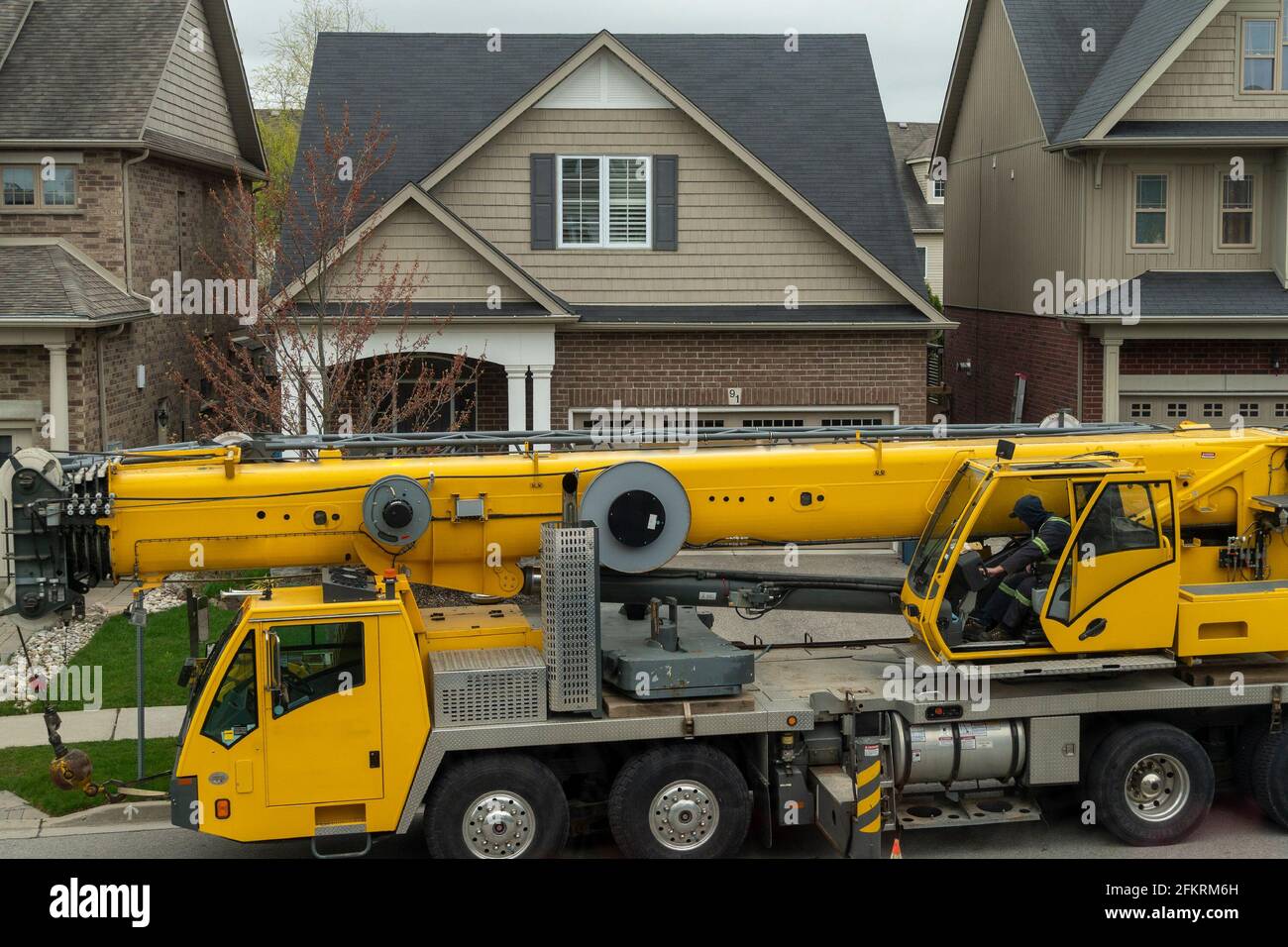 Preparing the crane for work in a residential area next to one of the ...