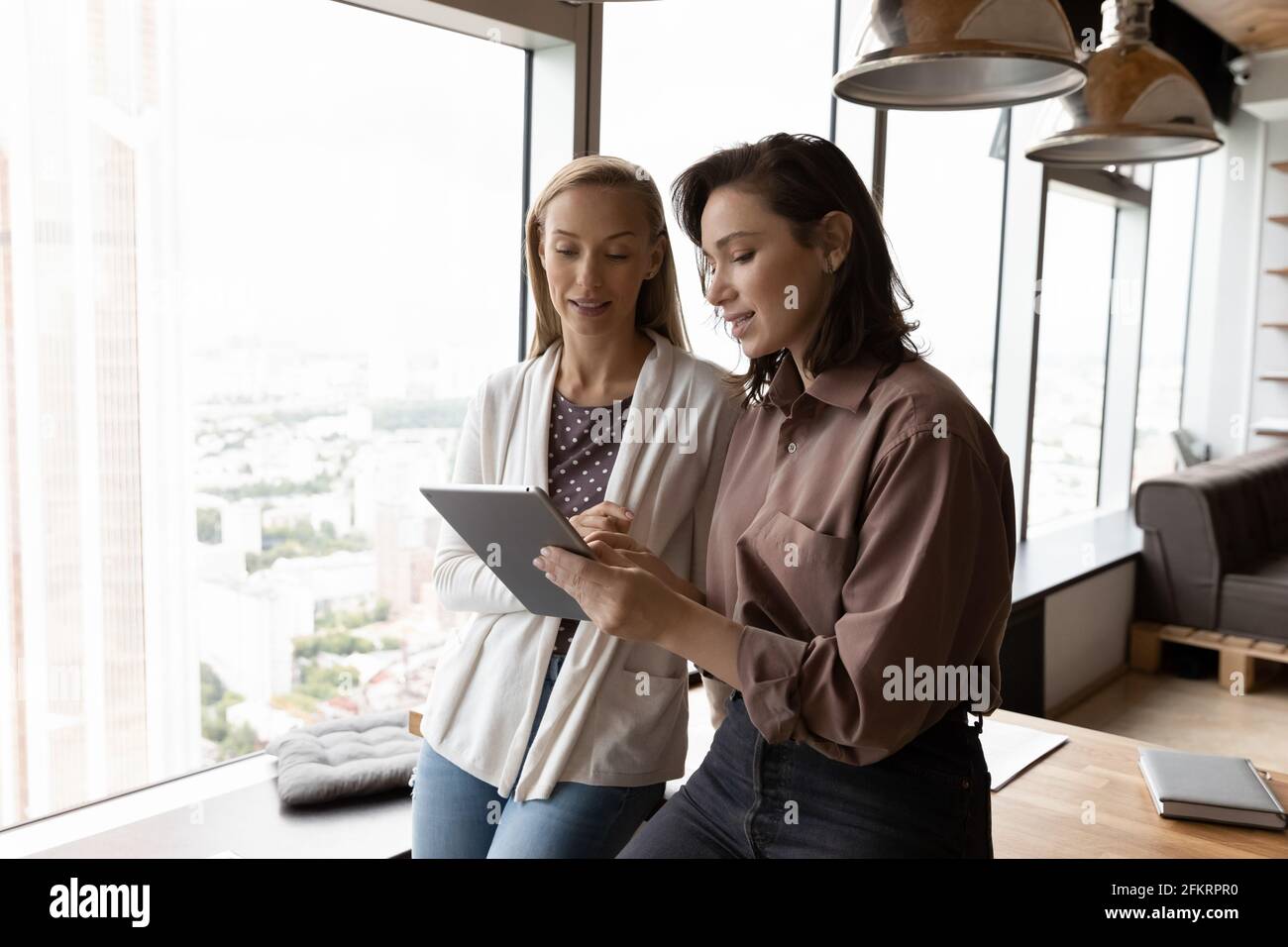 Female employees use modern tablet for work Stock Photo - Alamy